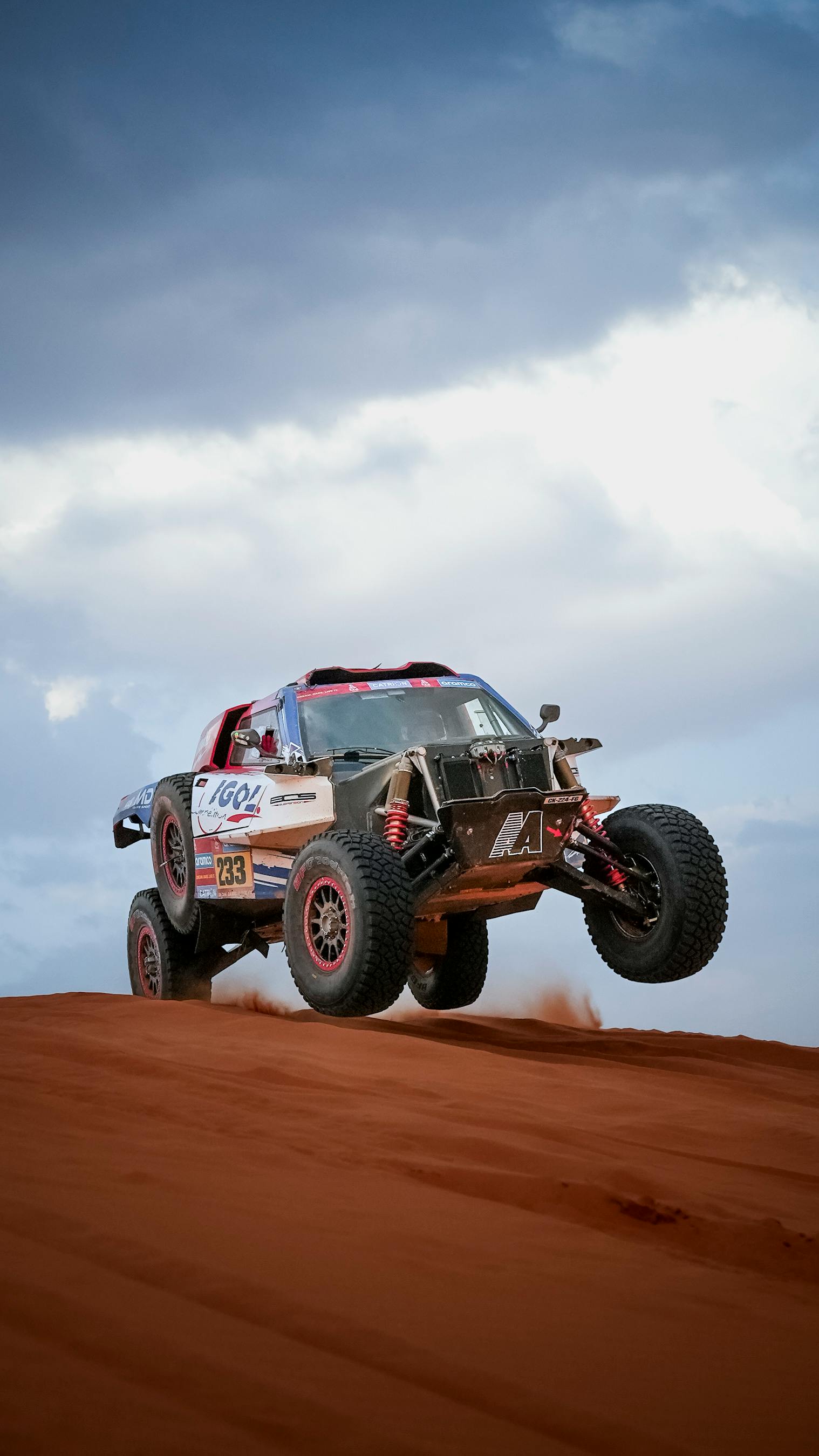 Dynamic Off-Road Racing Car on Desert Dune · Free Stock Photo