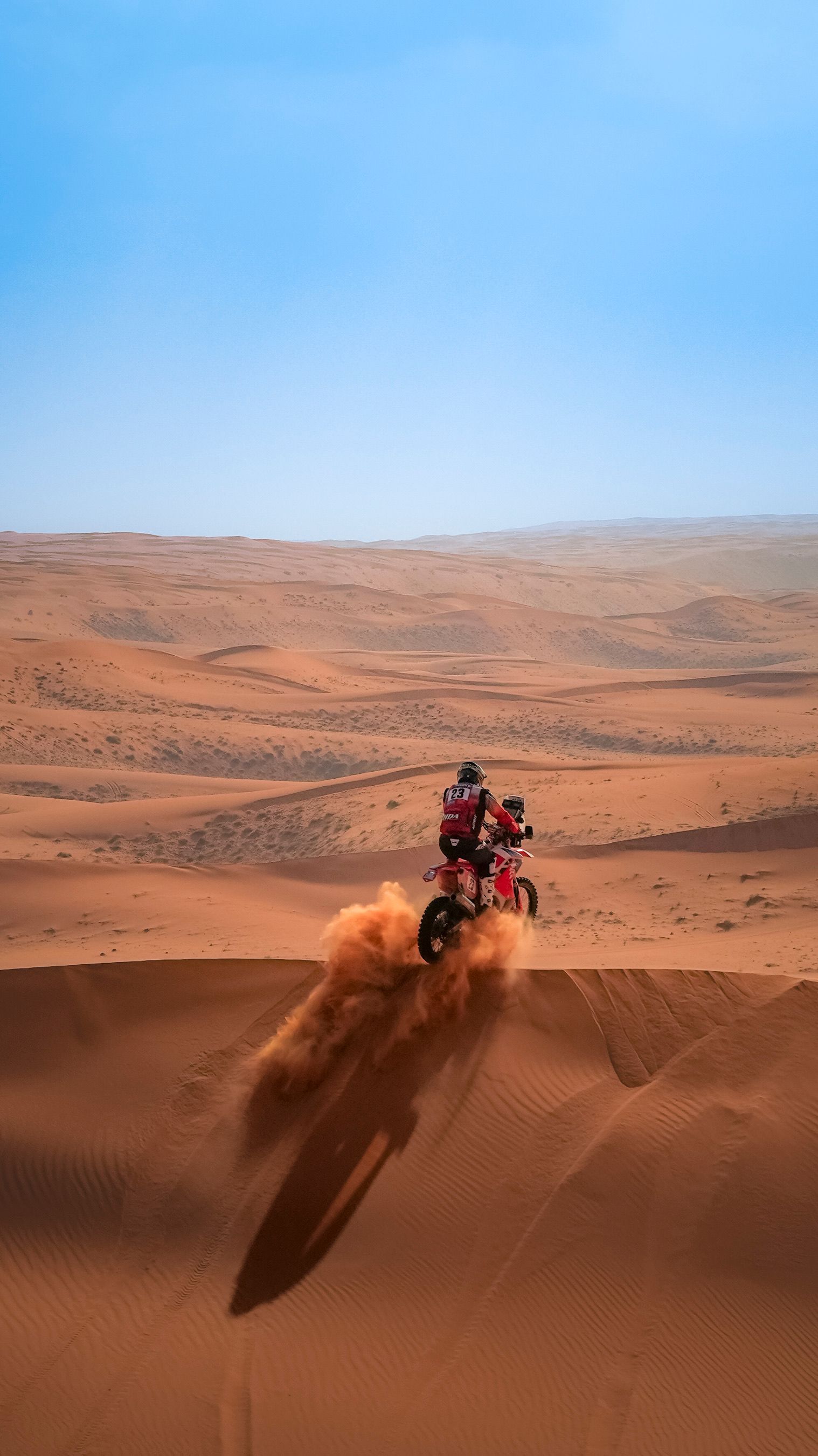 Dirt Biker Racing Across Desert Dunes · Free Stock Photo