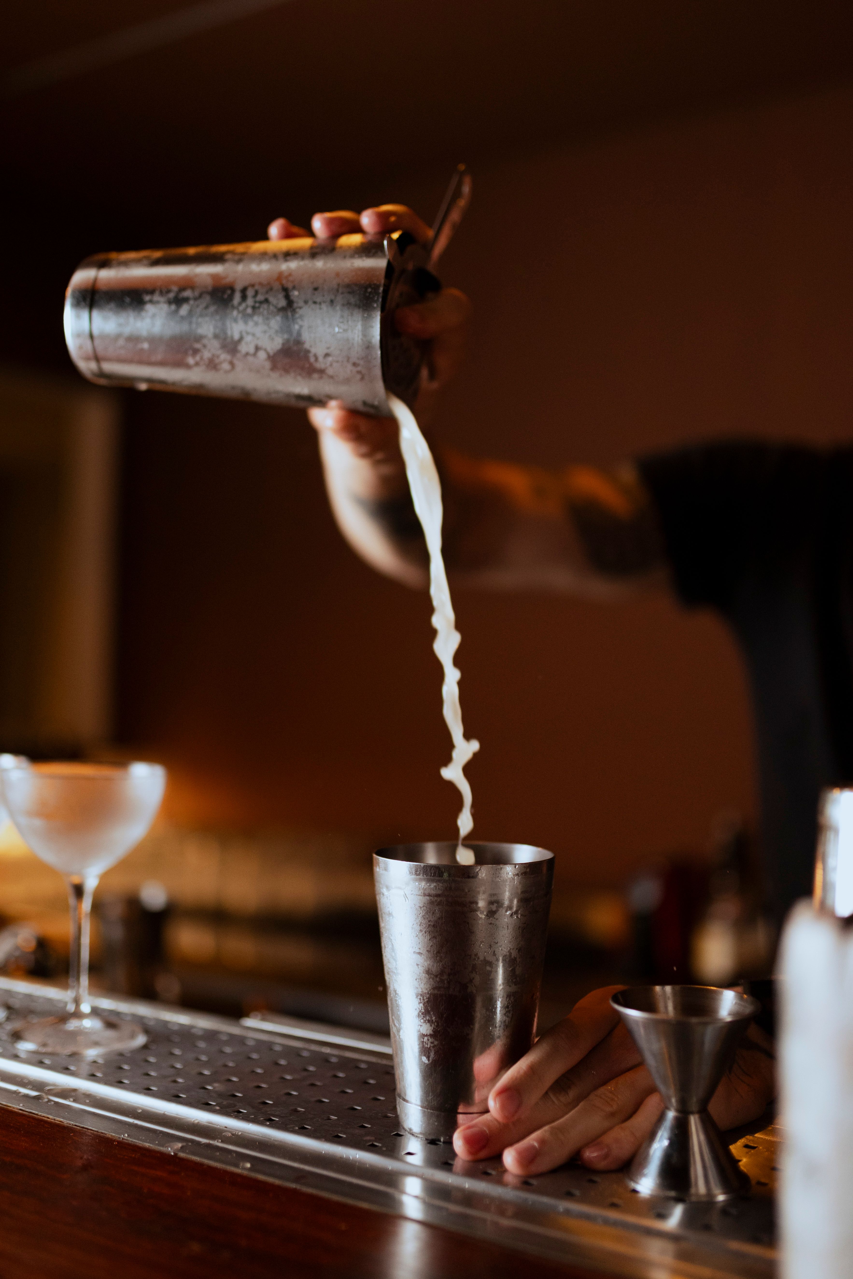 Bartender Pouring Cocktail at Bar · Free Stock Photo