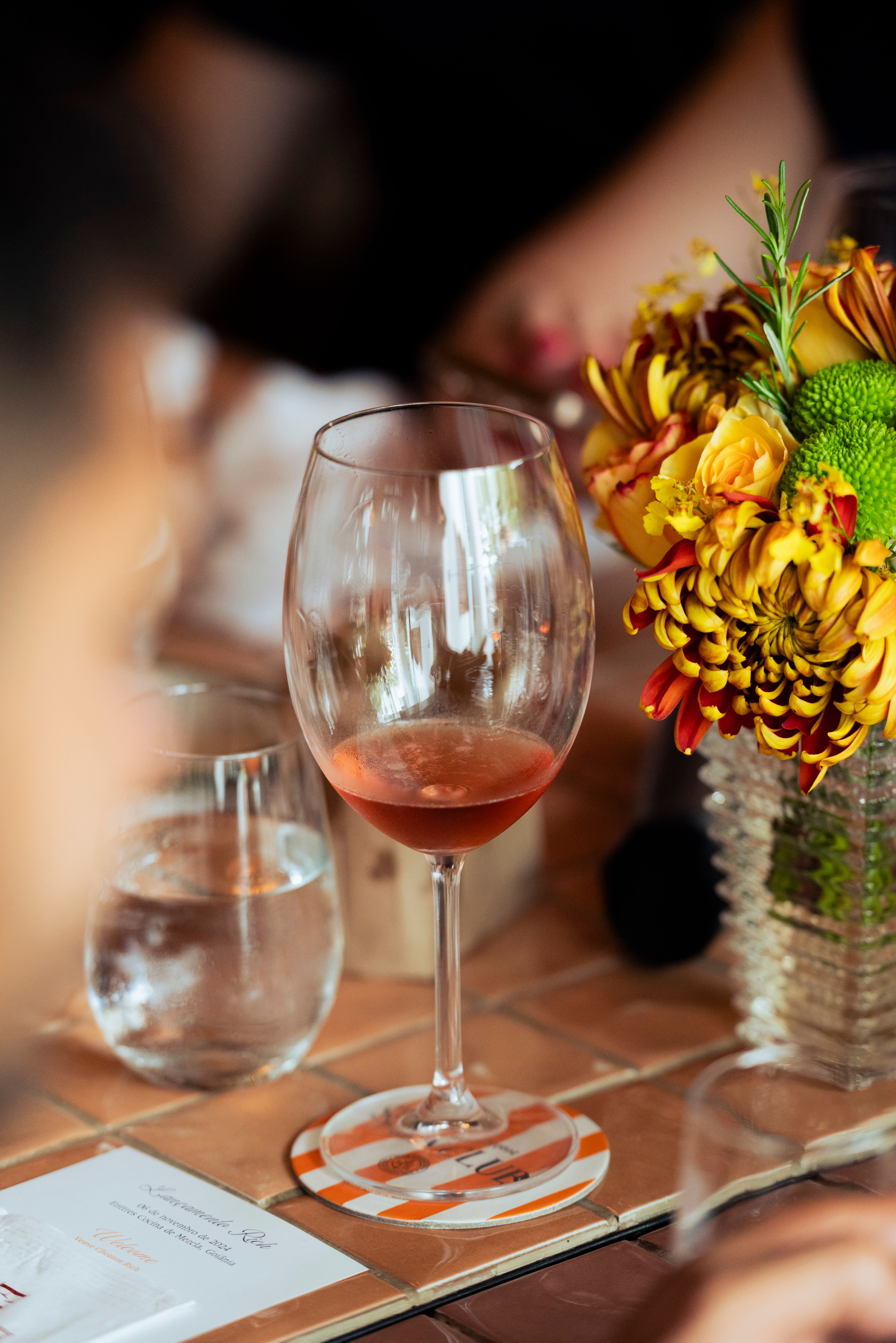 Glass of red wine served on wooden table decorated with flowers · Free ...