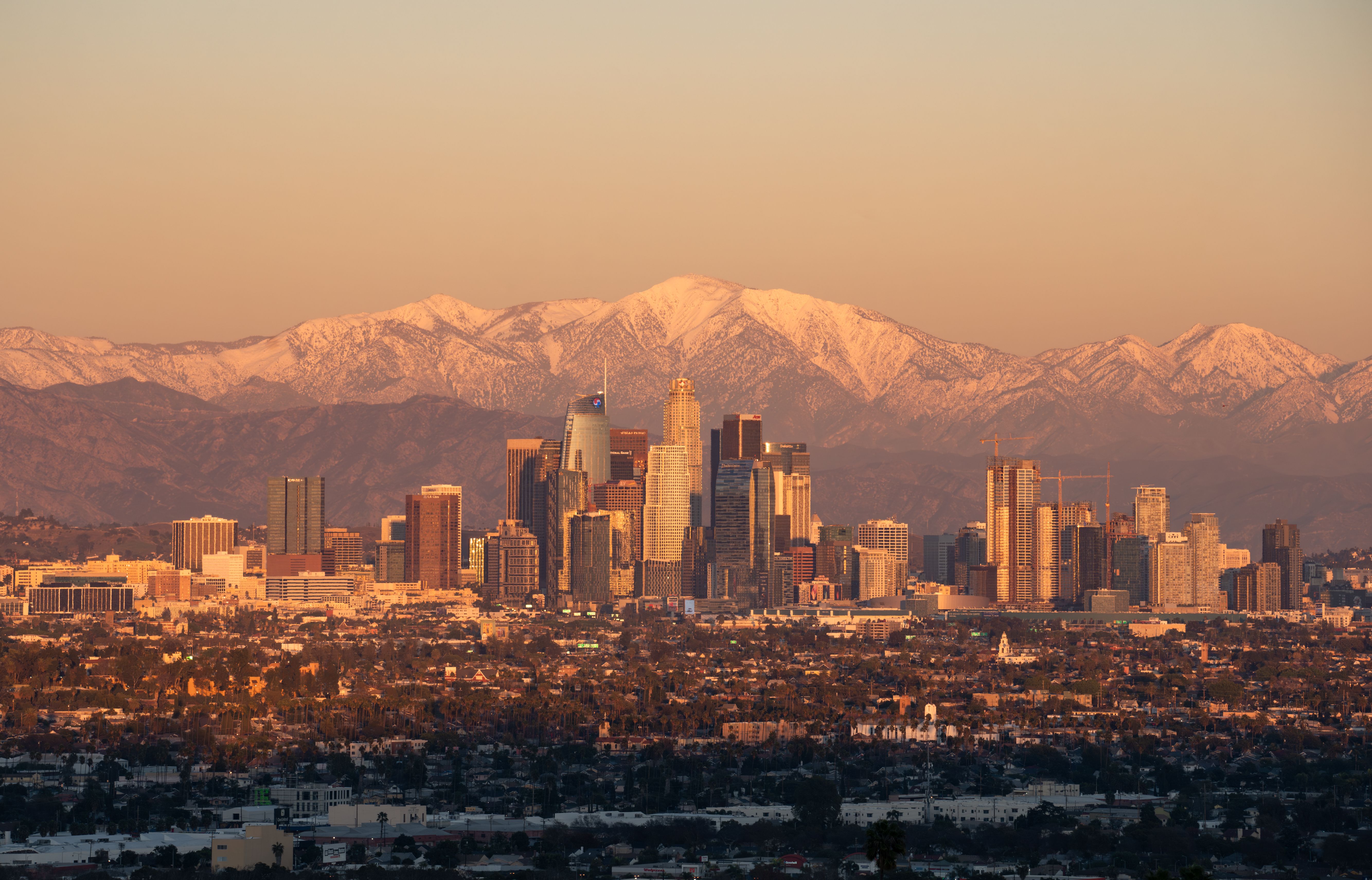 Golden Hour Los Angeles Skyline with Snowy Mountains · Free Stock Photo