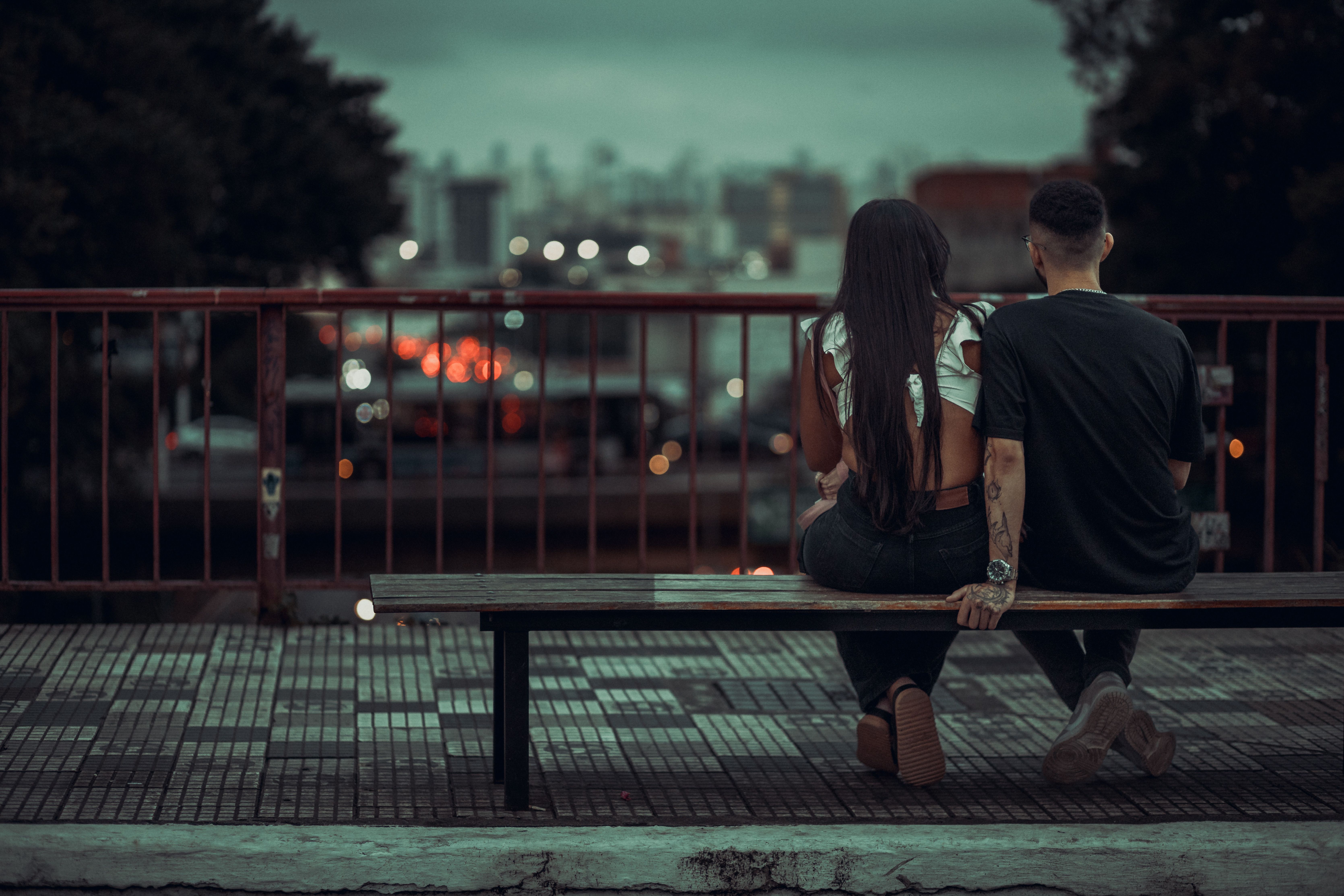 Romantic Couple Sitting on a Bench at Twilight · Free Stock Photo