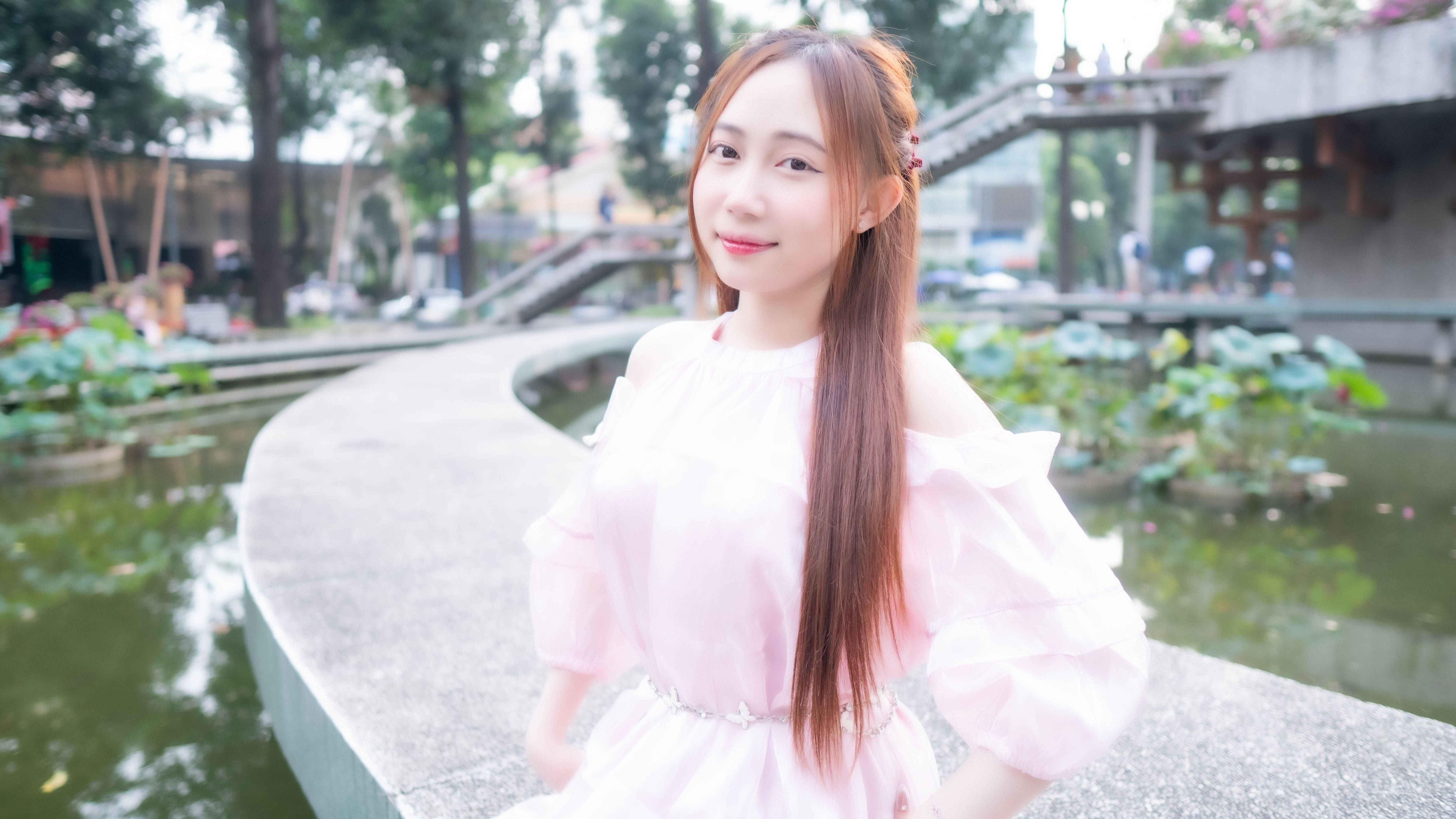 Young Woman Posing in Park with Pond · Free Stock Photo