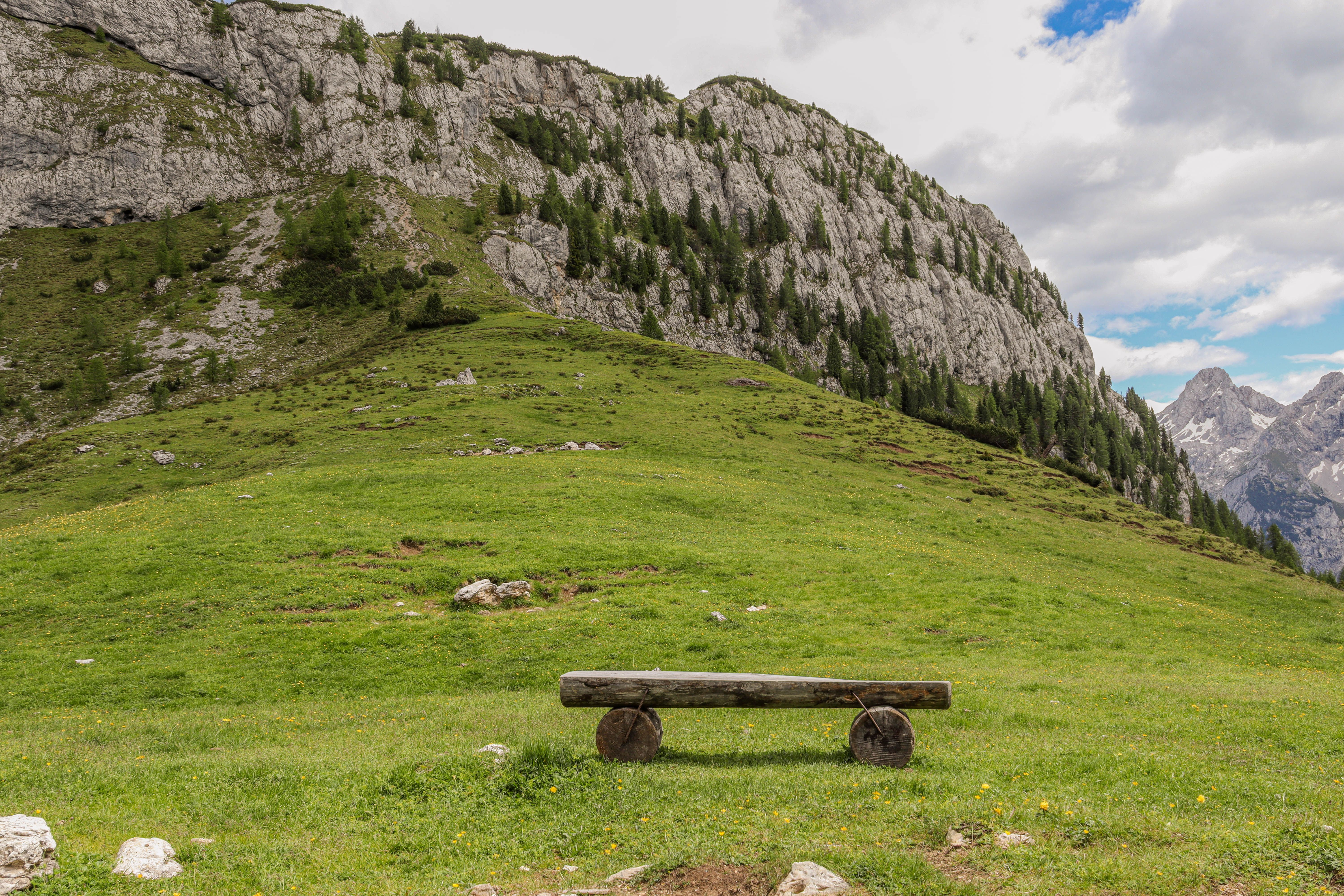 Scenic Mountain Landscape with Wooden Bench · Free Stock Photo