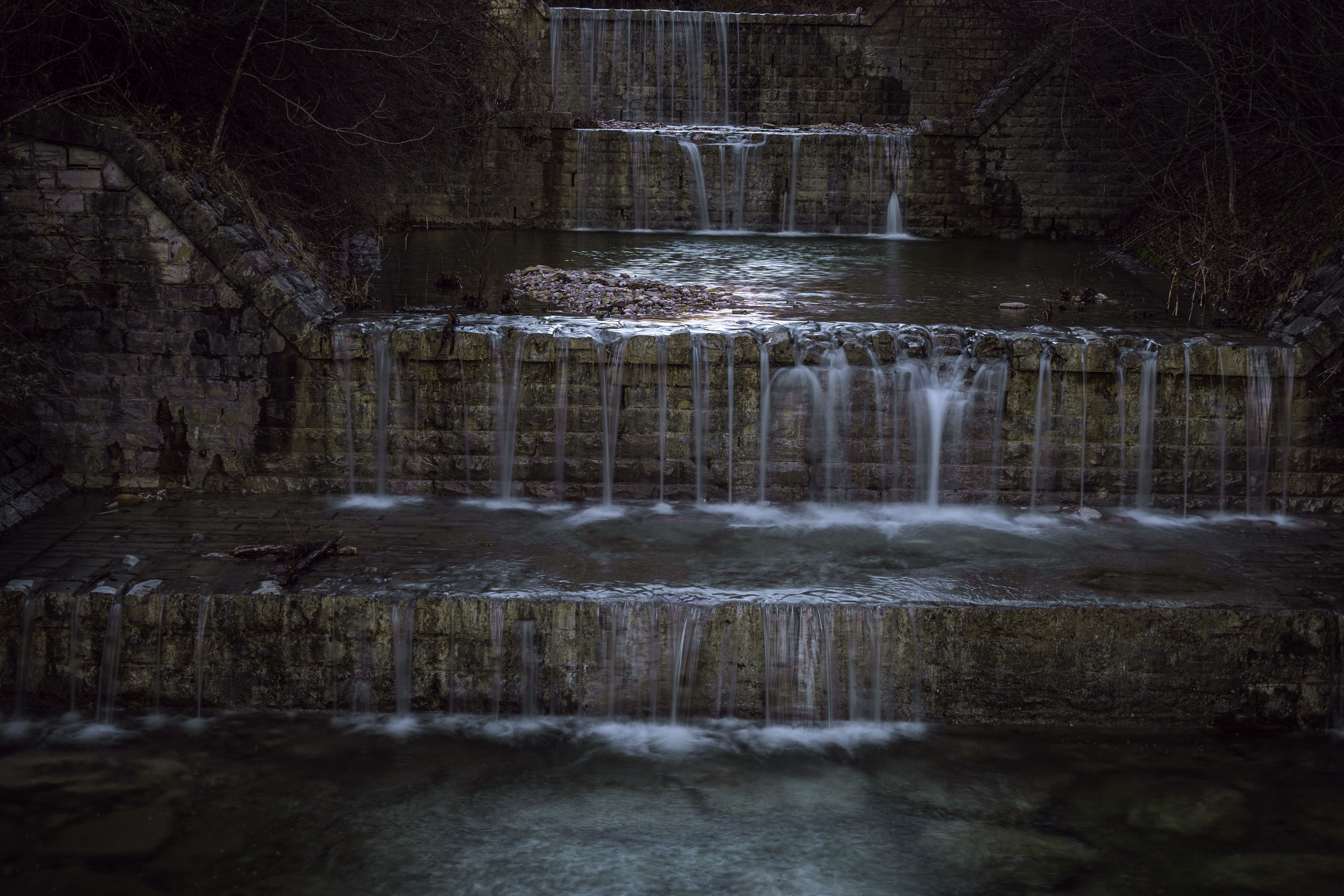 Serene Step Waterfalls in Tranquil Forest Setting · Free Stock Photo