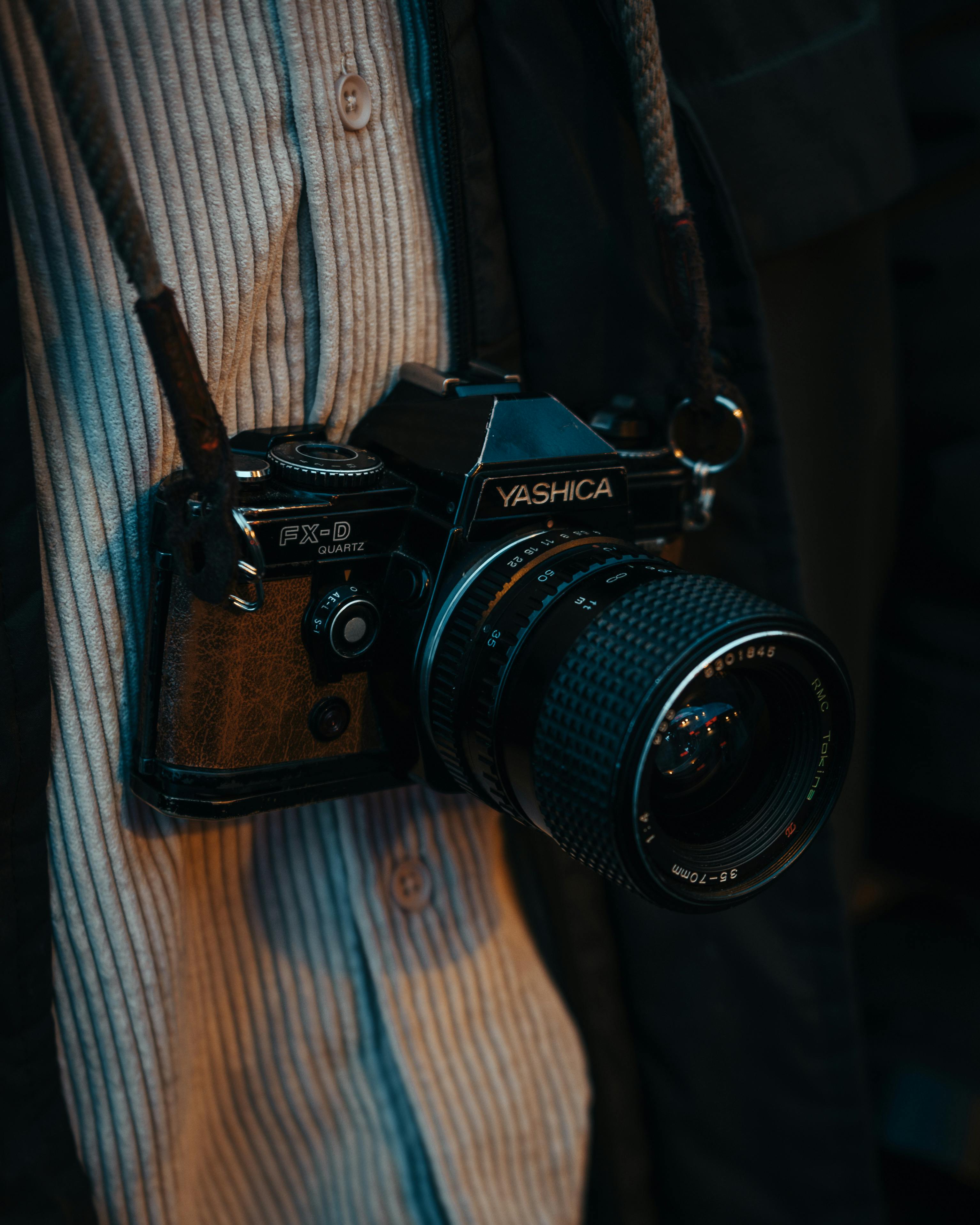 Vintage Yashica Camera on Striped Shirt · Free Stock Photo