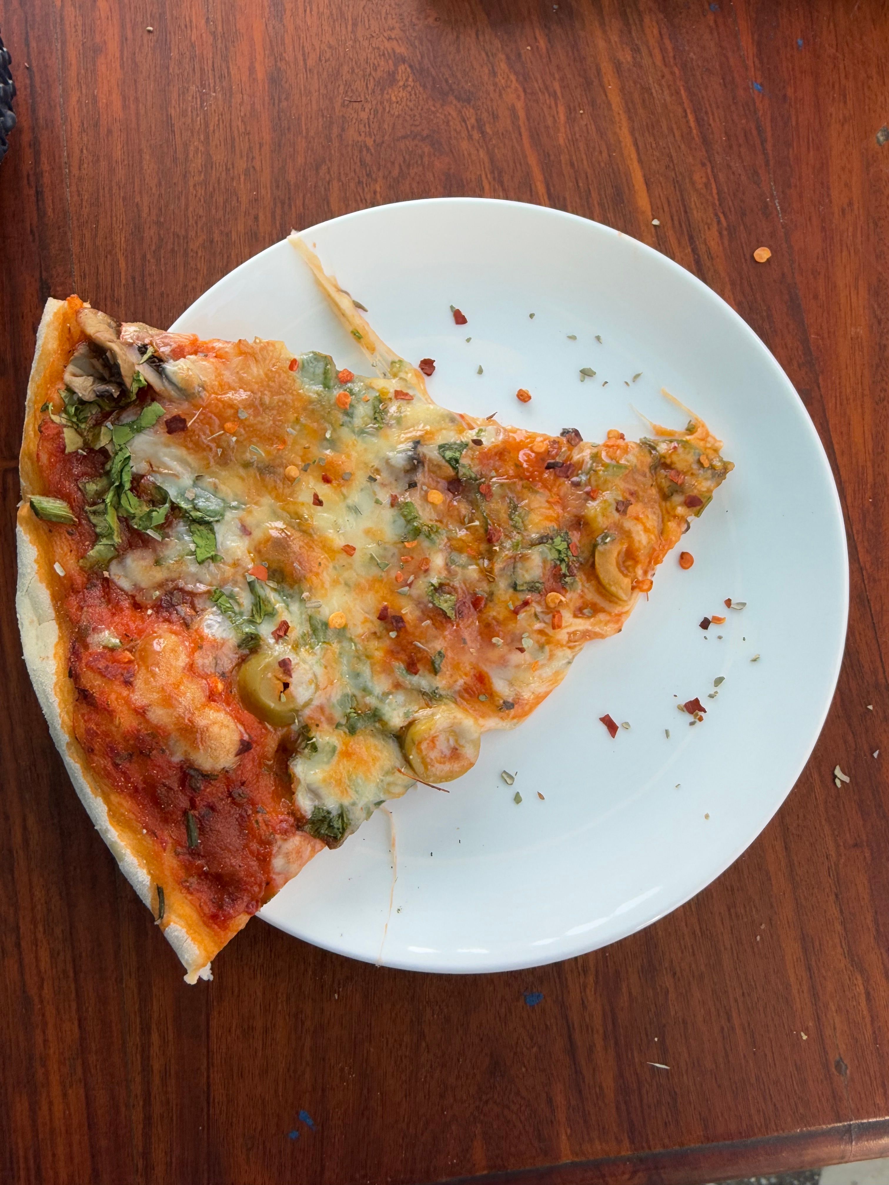 Gourmet Pizza Slice on Wooden Table Surface · Free Stock Photo