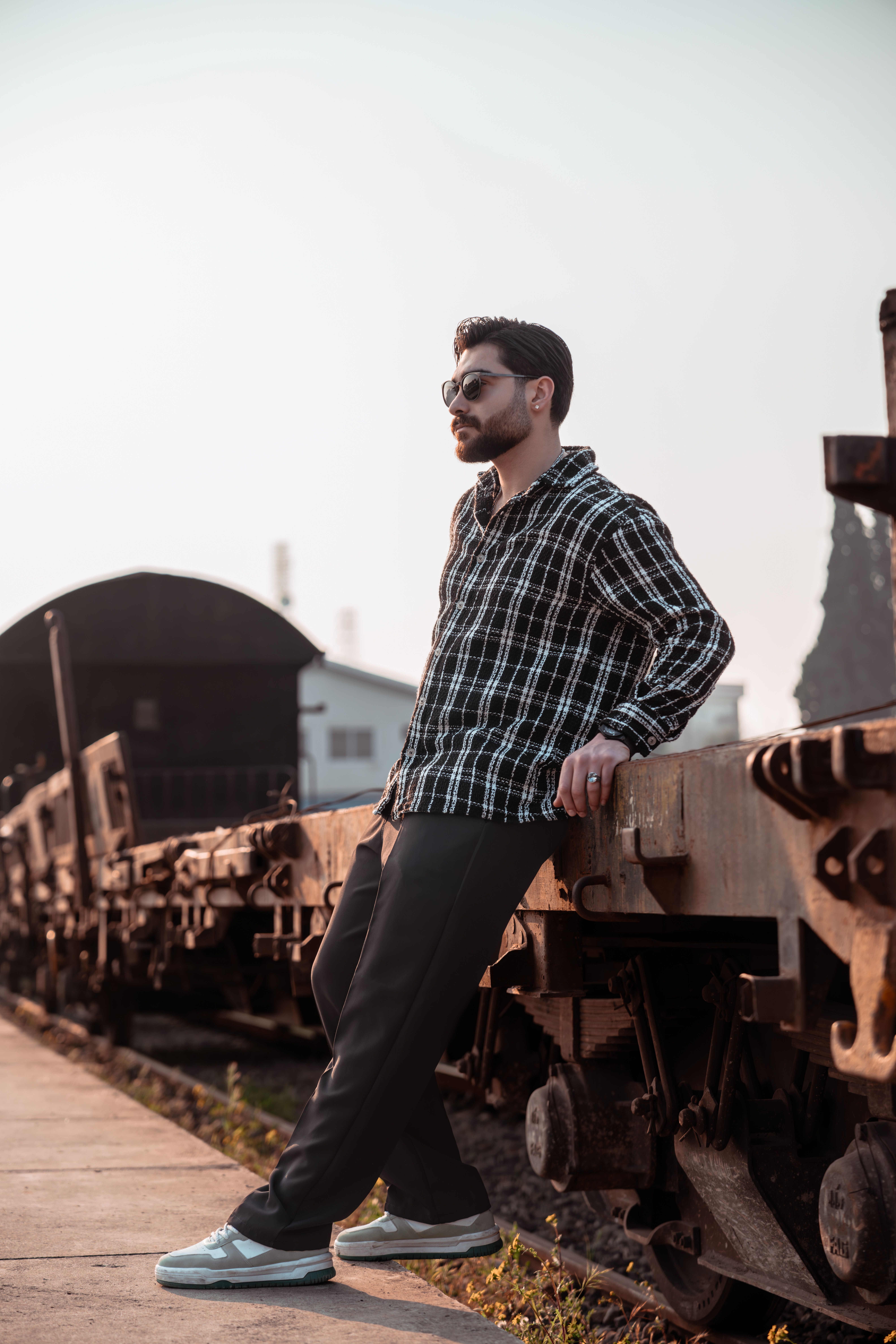 Man in Casual Attire Leaning on Old Train Track · Free Stock Photo