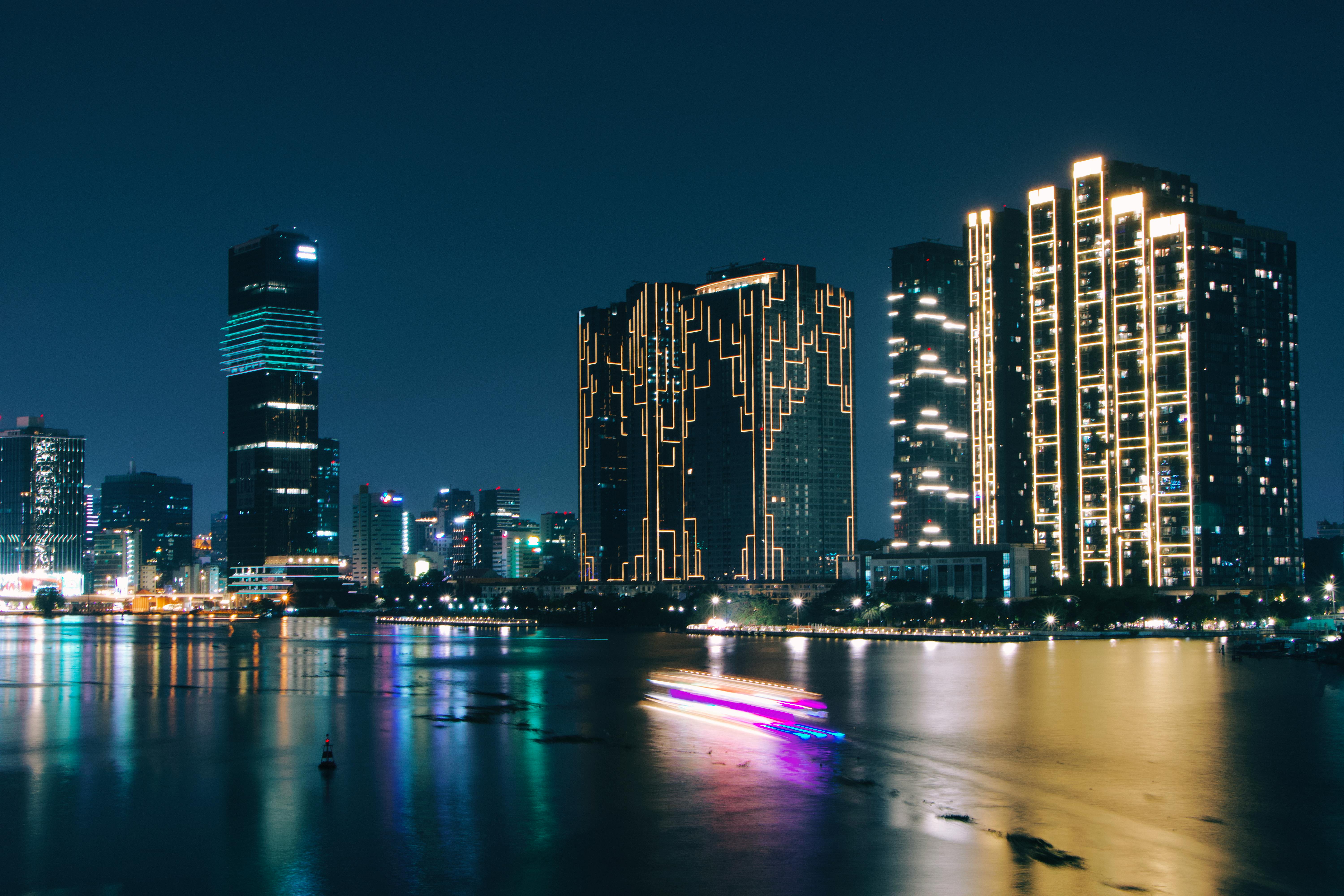 Vibrant City Skyline at Night with Illuminated Buildings · Free Stock Photo