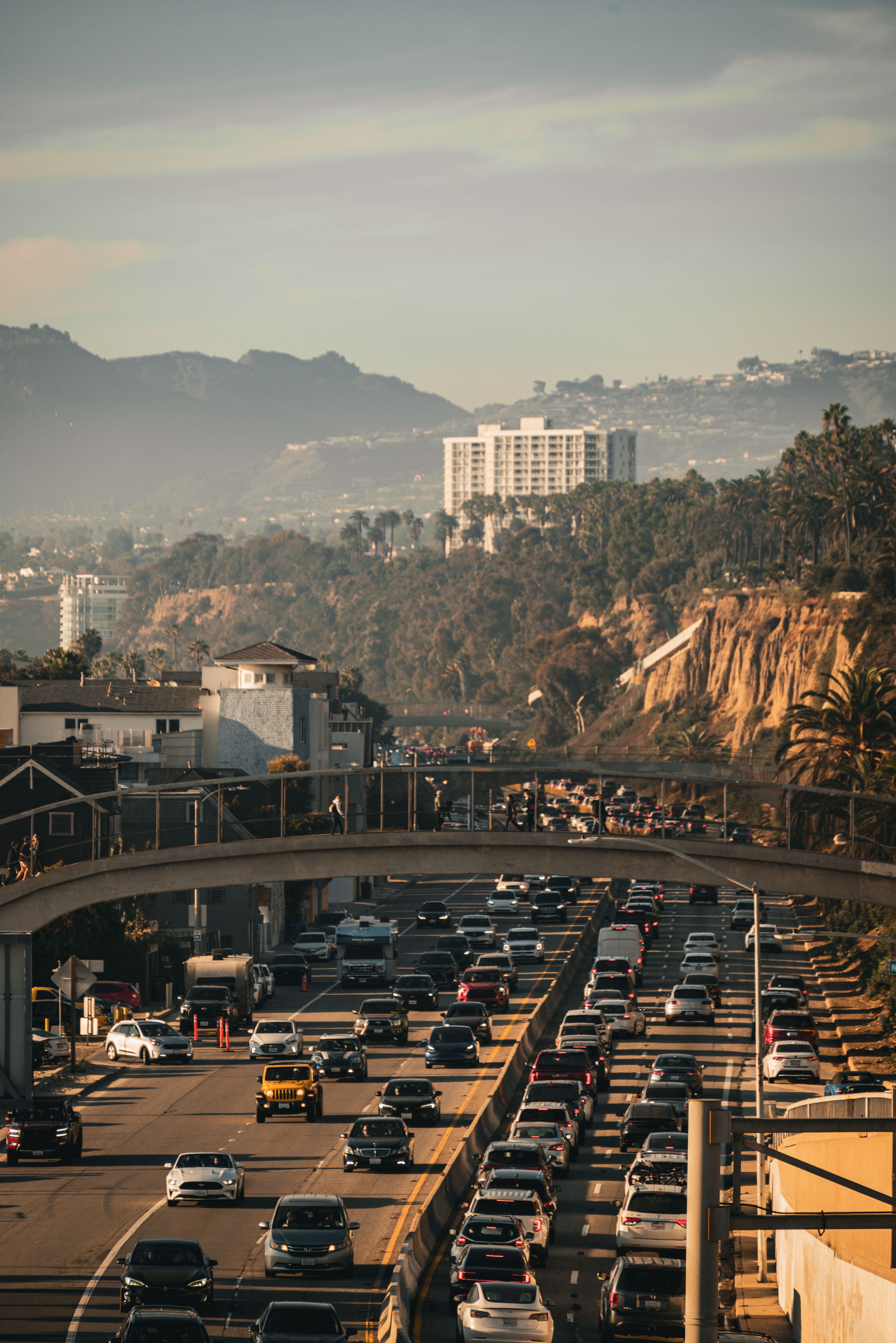 Busy Highway Traffic with Scenic Mountain Views · Free Stock Photo