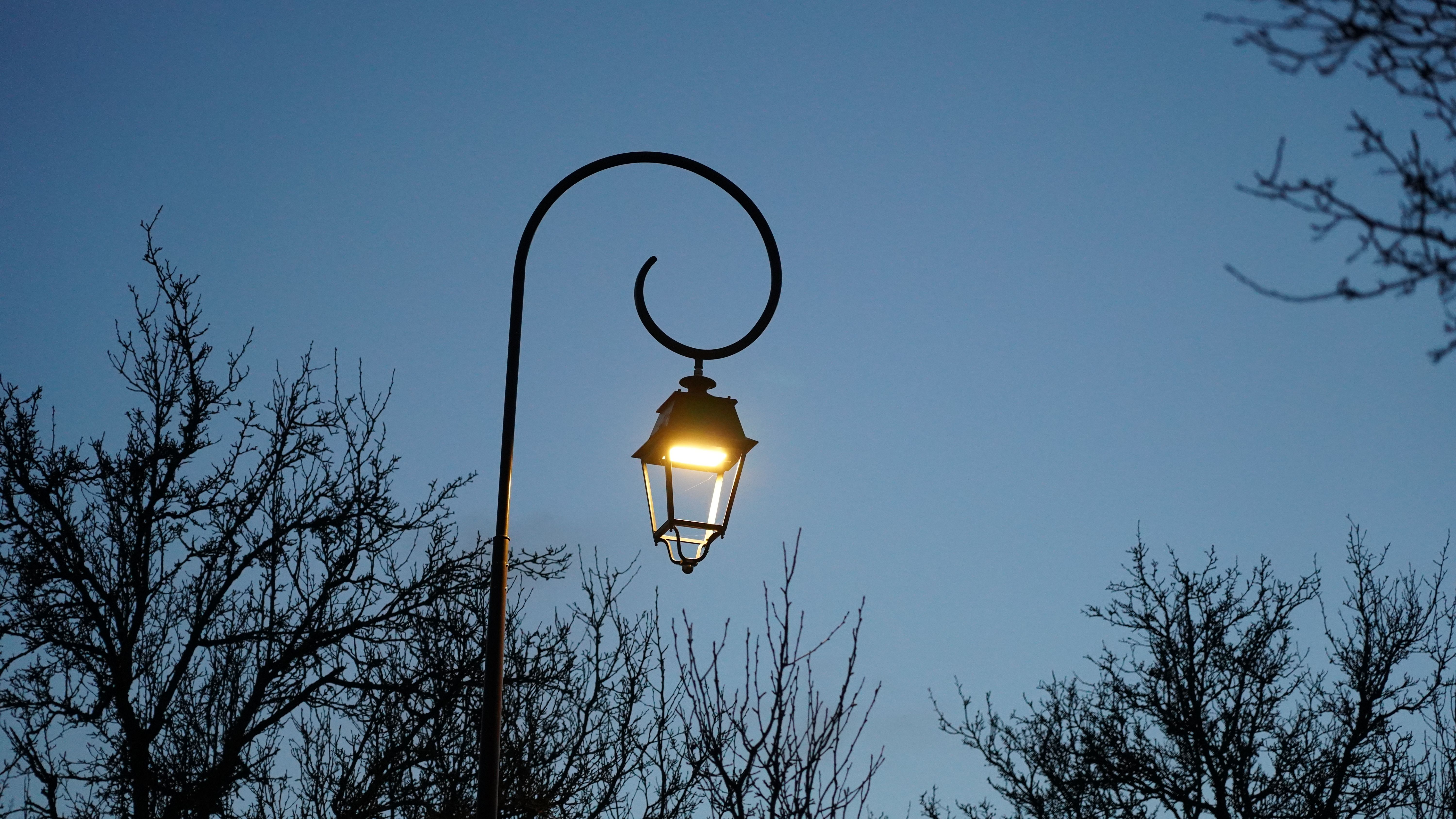 Elegant street lamp illuminating twilight sky · Free Stock Photo