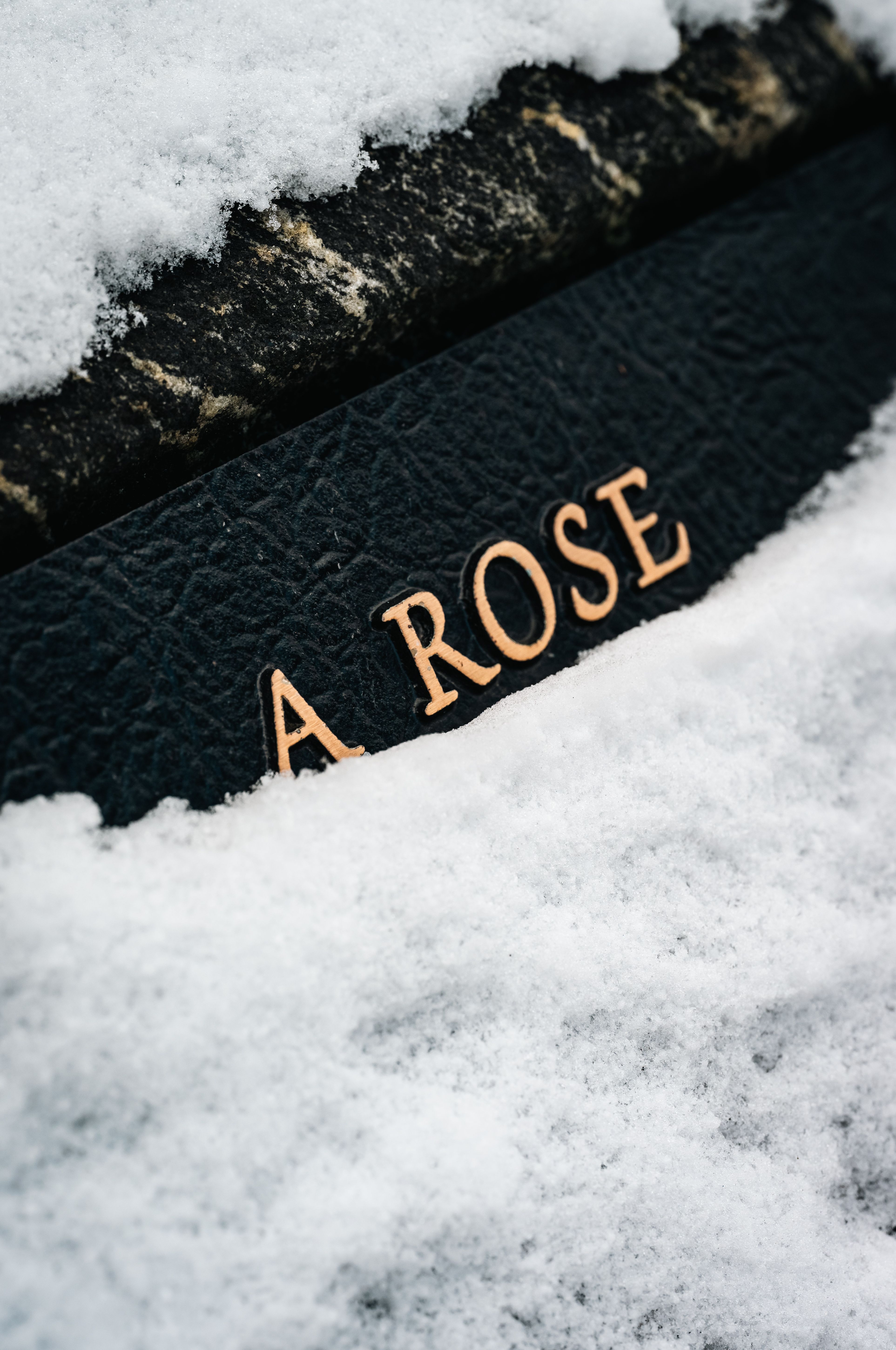 Snow-Covered Textured Stone with Inscription · Free Stock Photo
