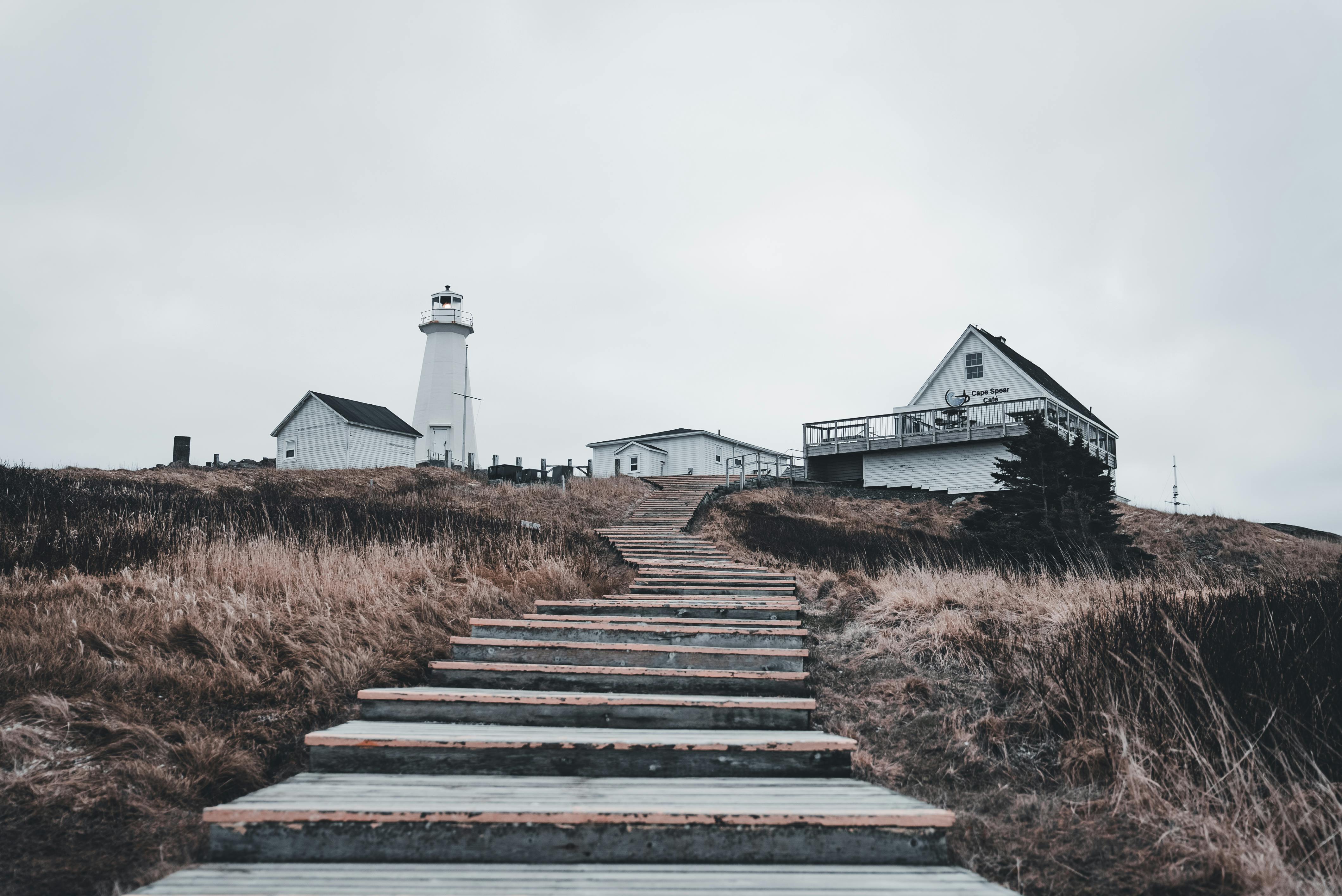 Rustic Lighthouse with Wooden Pathway in Overcast Weather · Free Stock ...