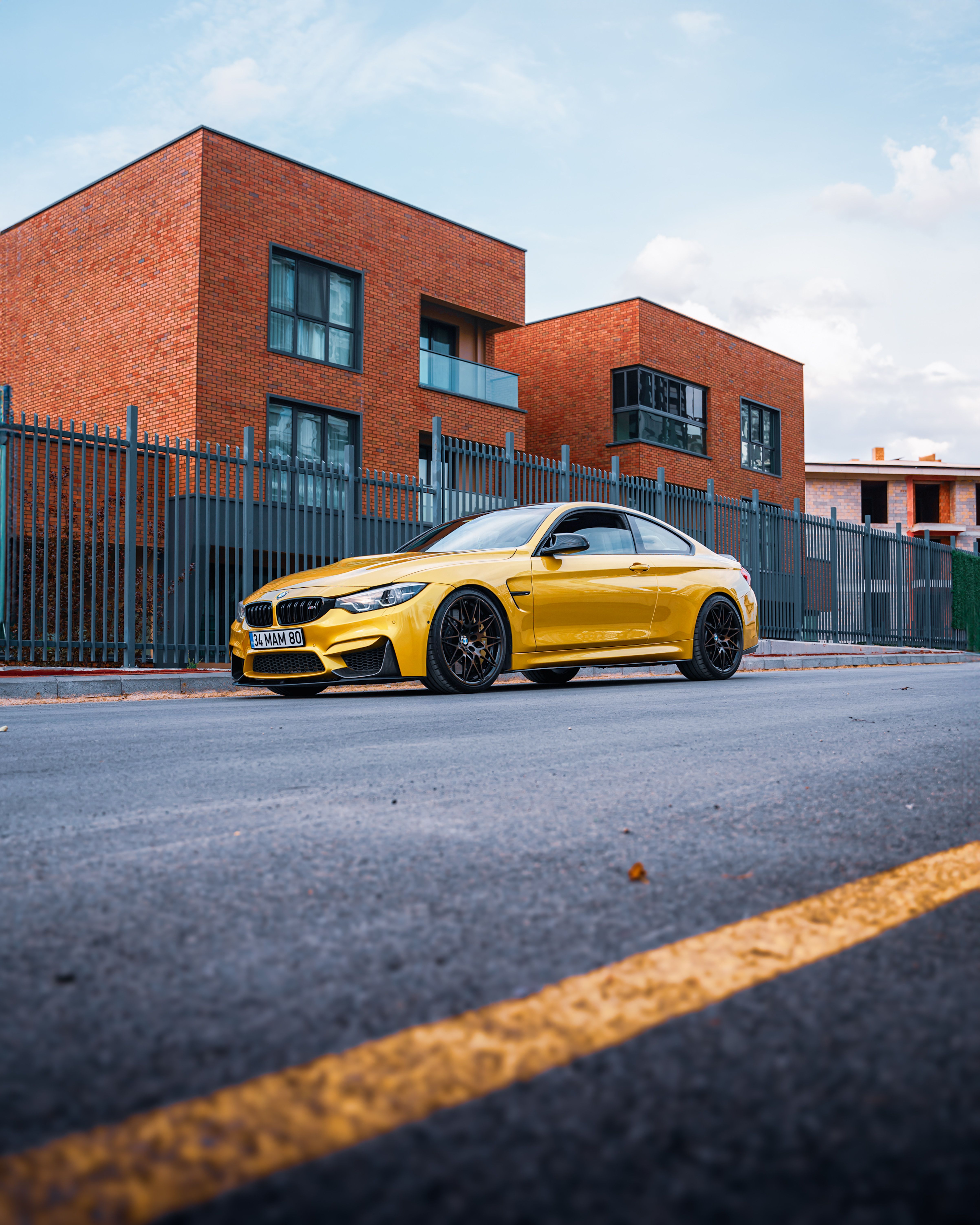 Yellow BMW Coupe in Modern Urban Setting · Free Stock Photo