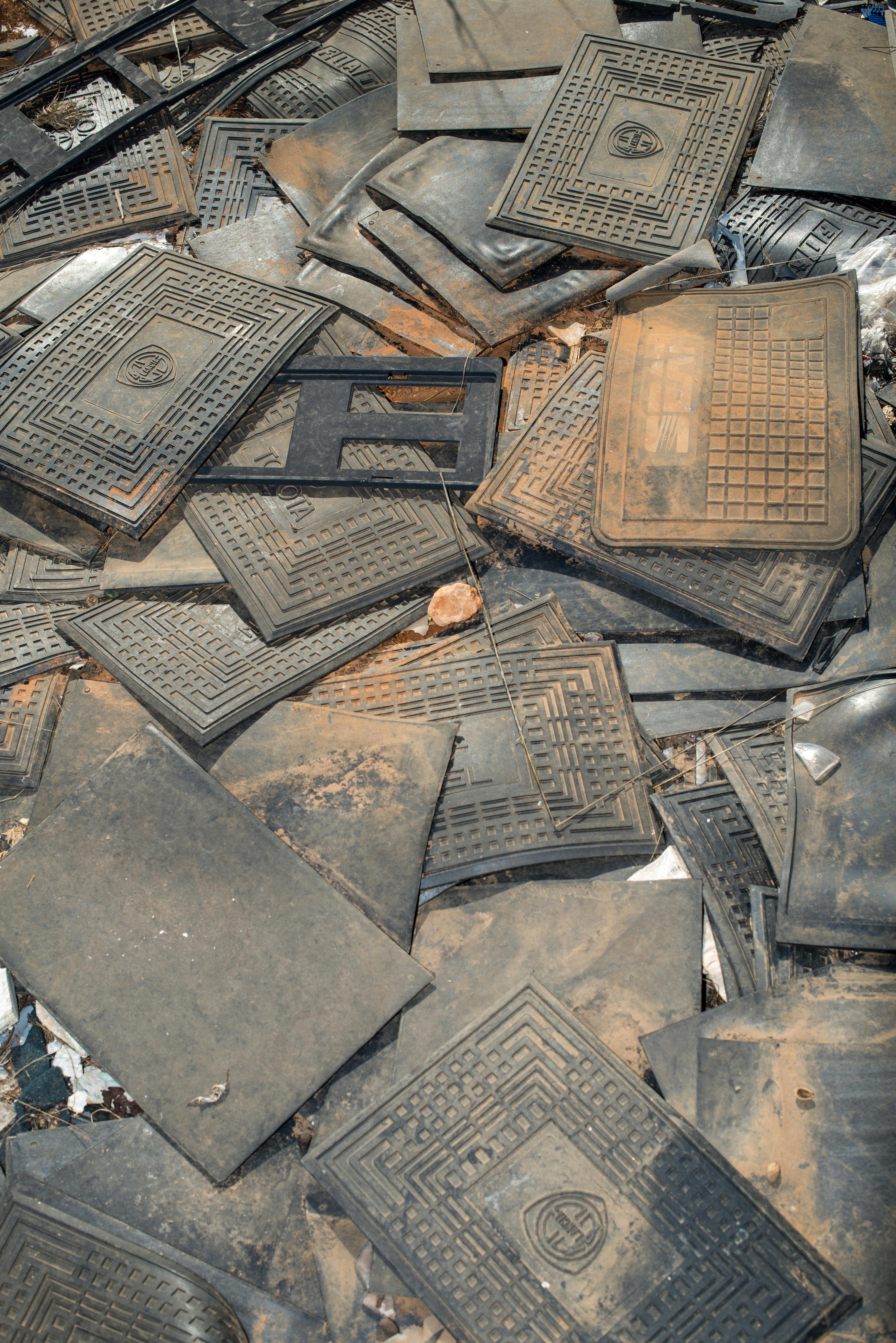 Pile of Worn Rubber Mats Outdoors · Free Stock Photo