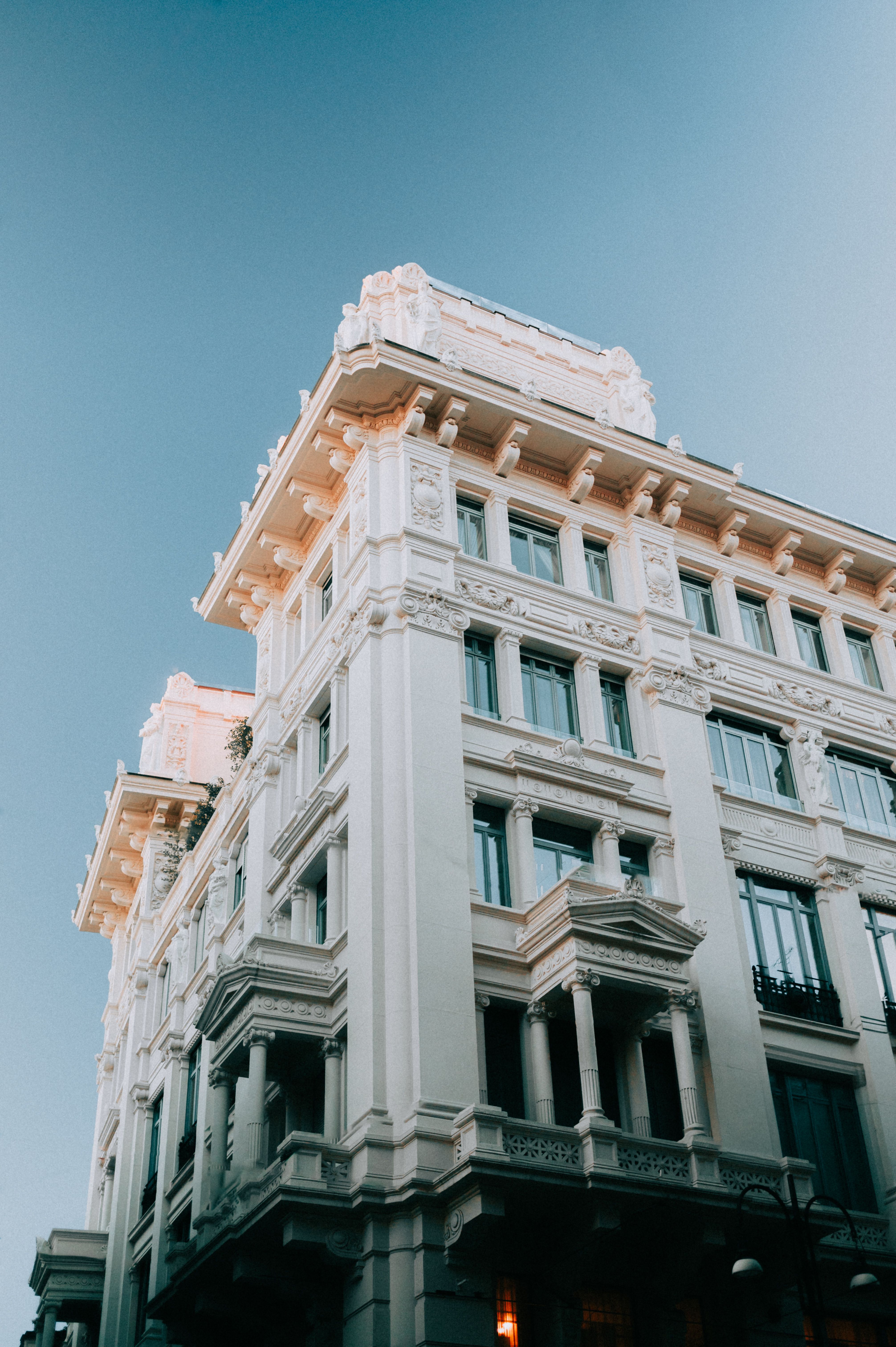 Elegant White Building Against Blue Sky · Free Stock Photo