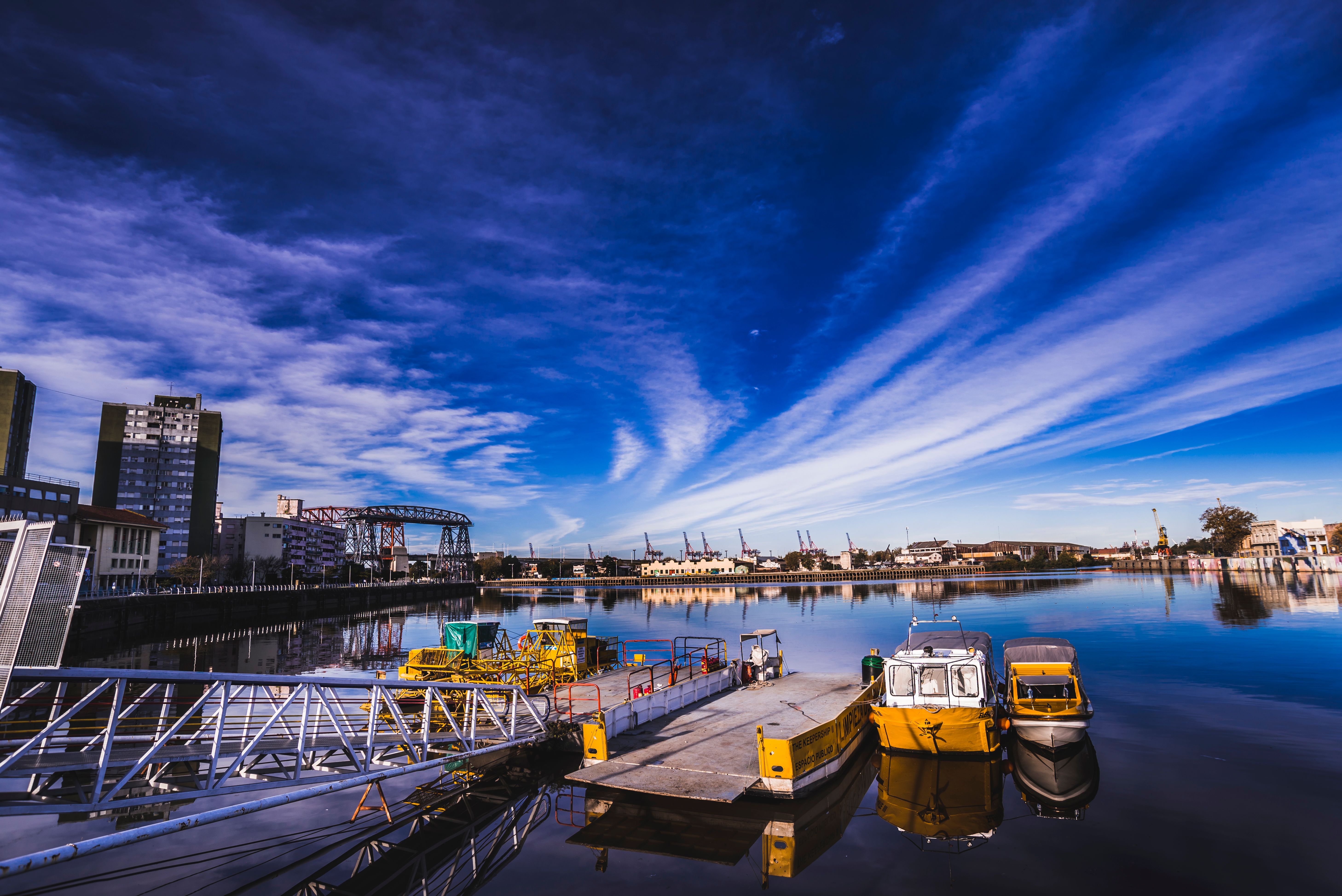 Colorful Waterfront with Boats and Dramatic Sky · Free Stock Photo
