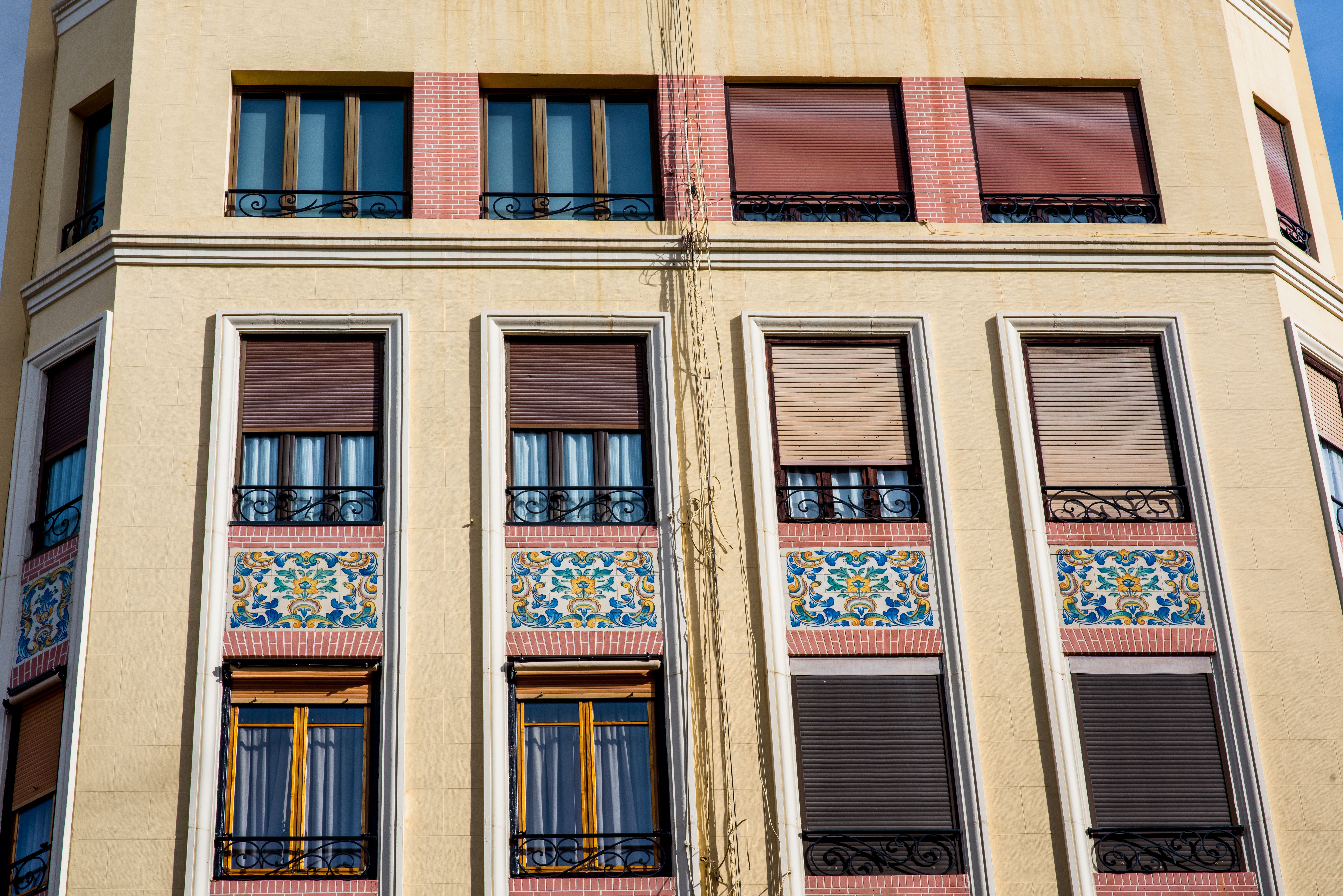 Colorful facade with decorative tiles and windows · Free Stock Photo