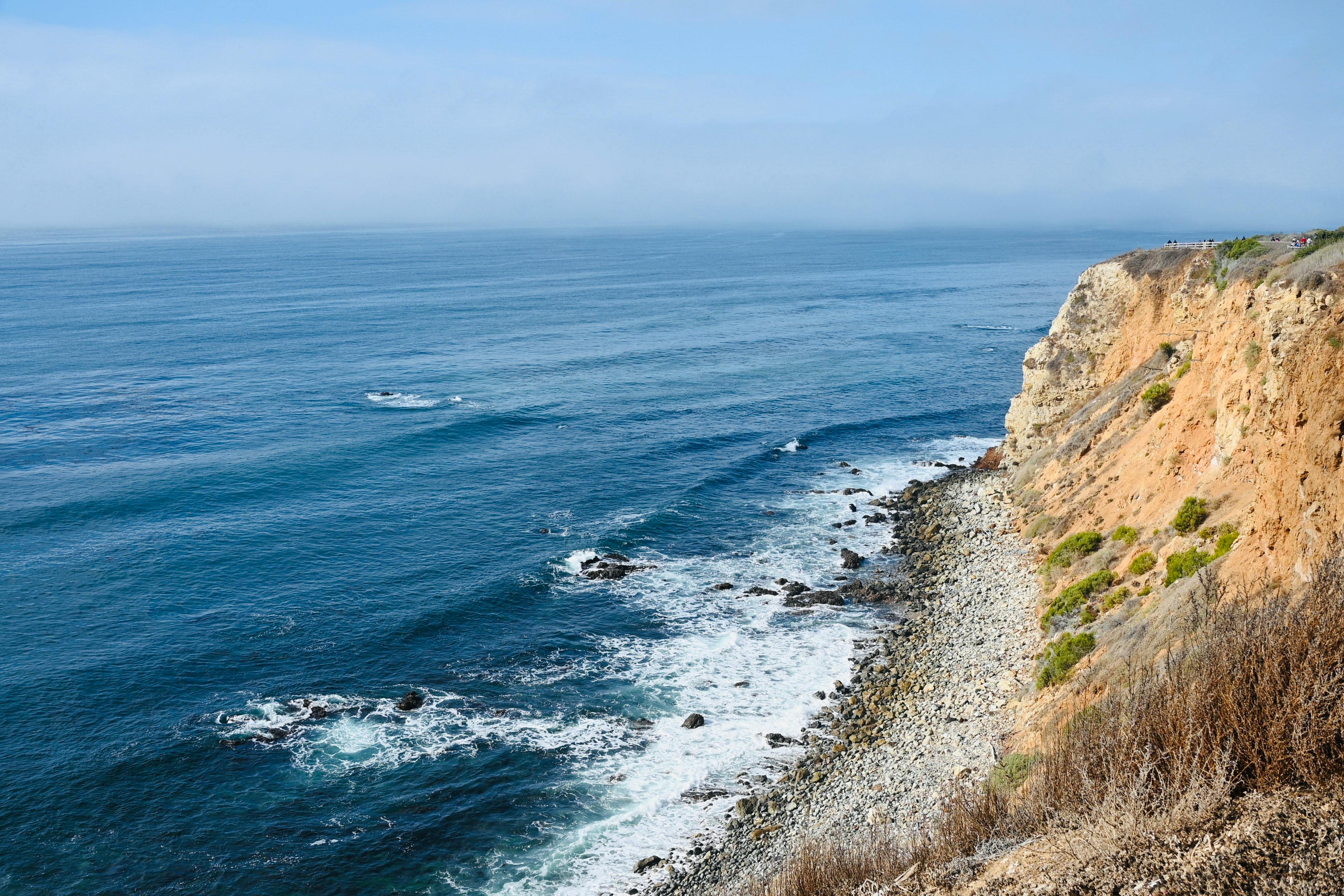 Scenic Coastal Cliffside with Ocean Waves · Free Stock Photo