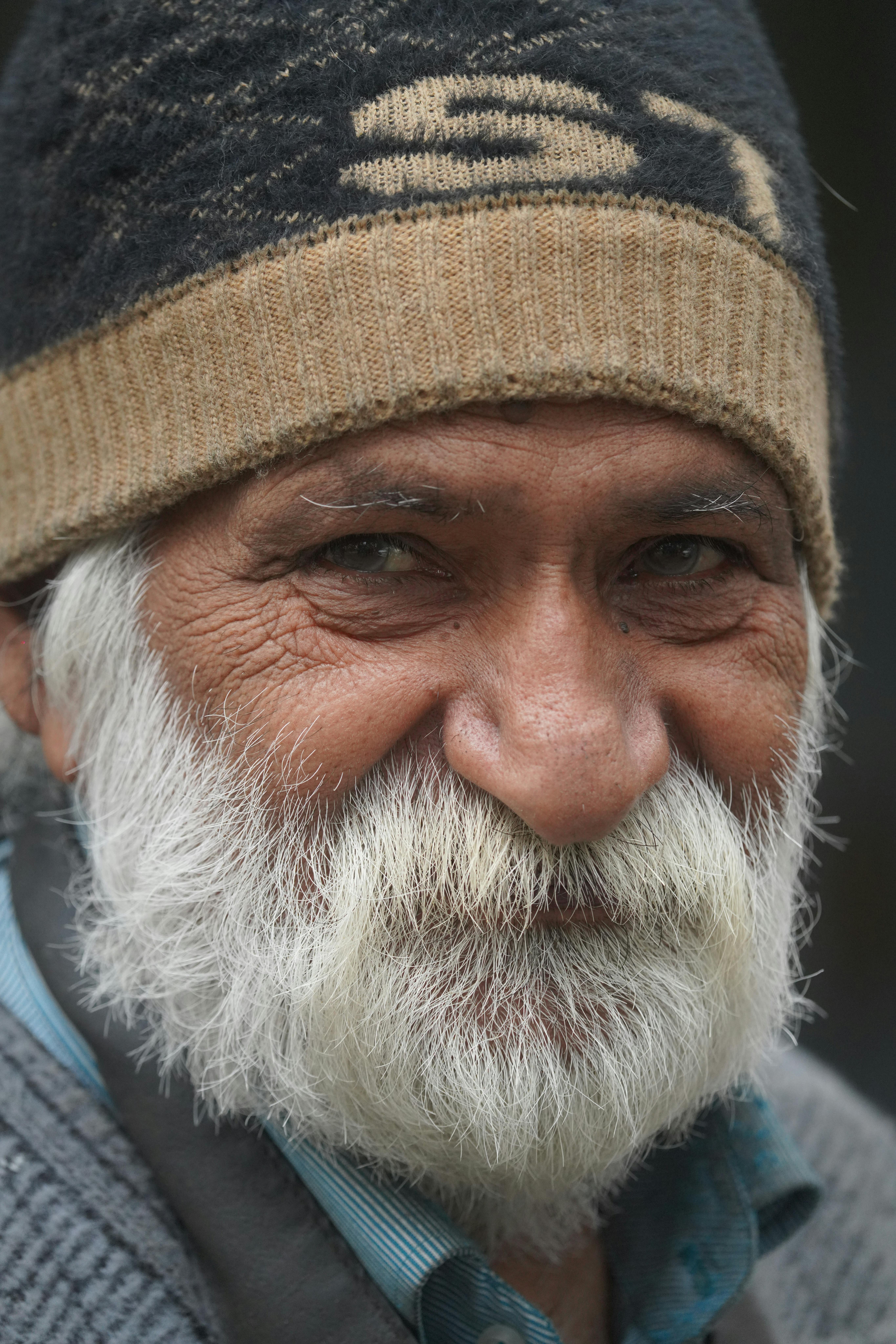 Portrait of a Smiling Elderly Man with Beard · Free Stock Photo