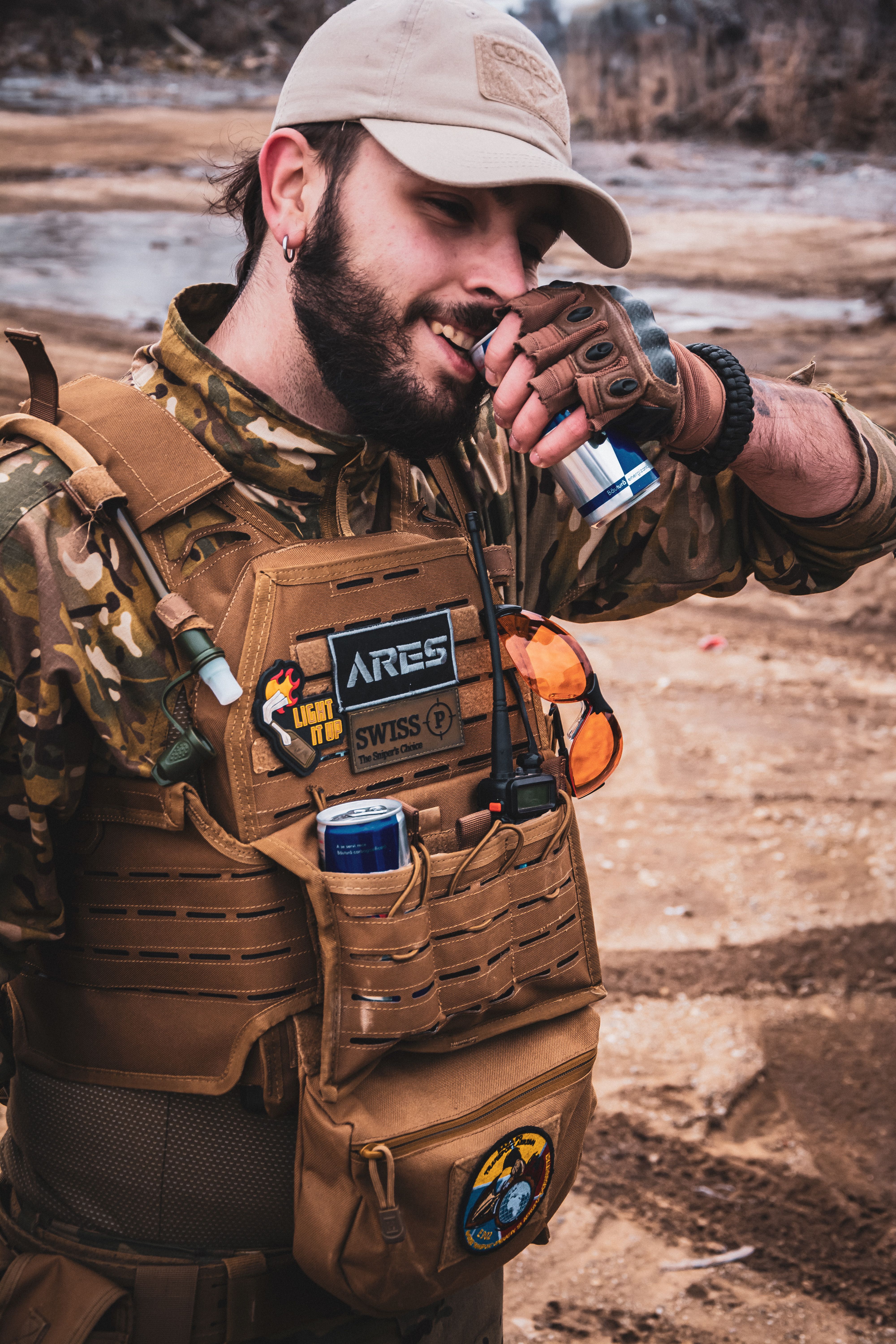 Tactical Gear Enthusiast Outdoors with Energy Drink · Free Stock Photo