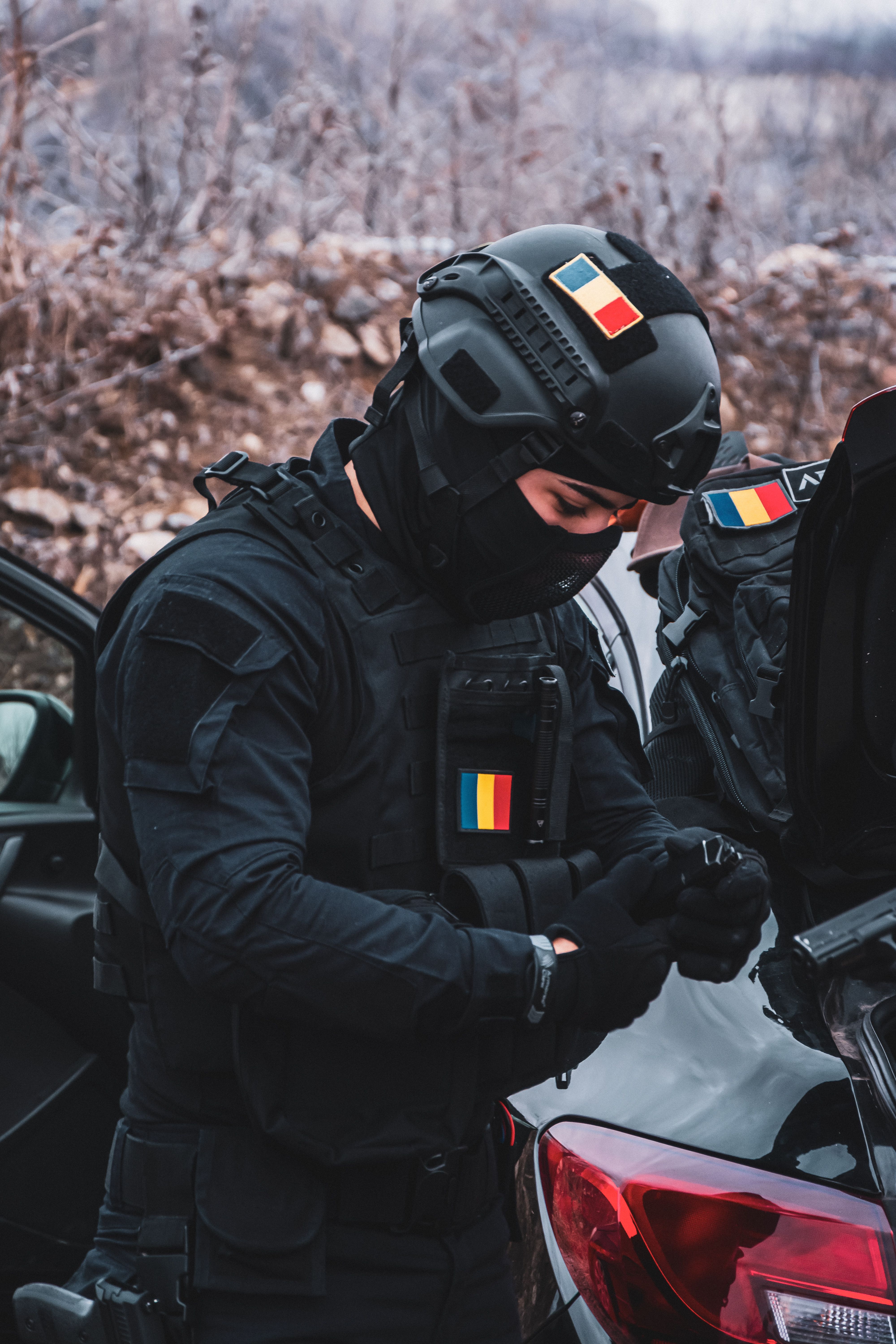 Tactical Officer in Winter Gear Preparing for Duty · Free Stock Photo