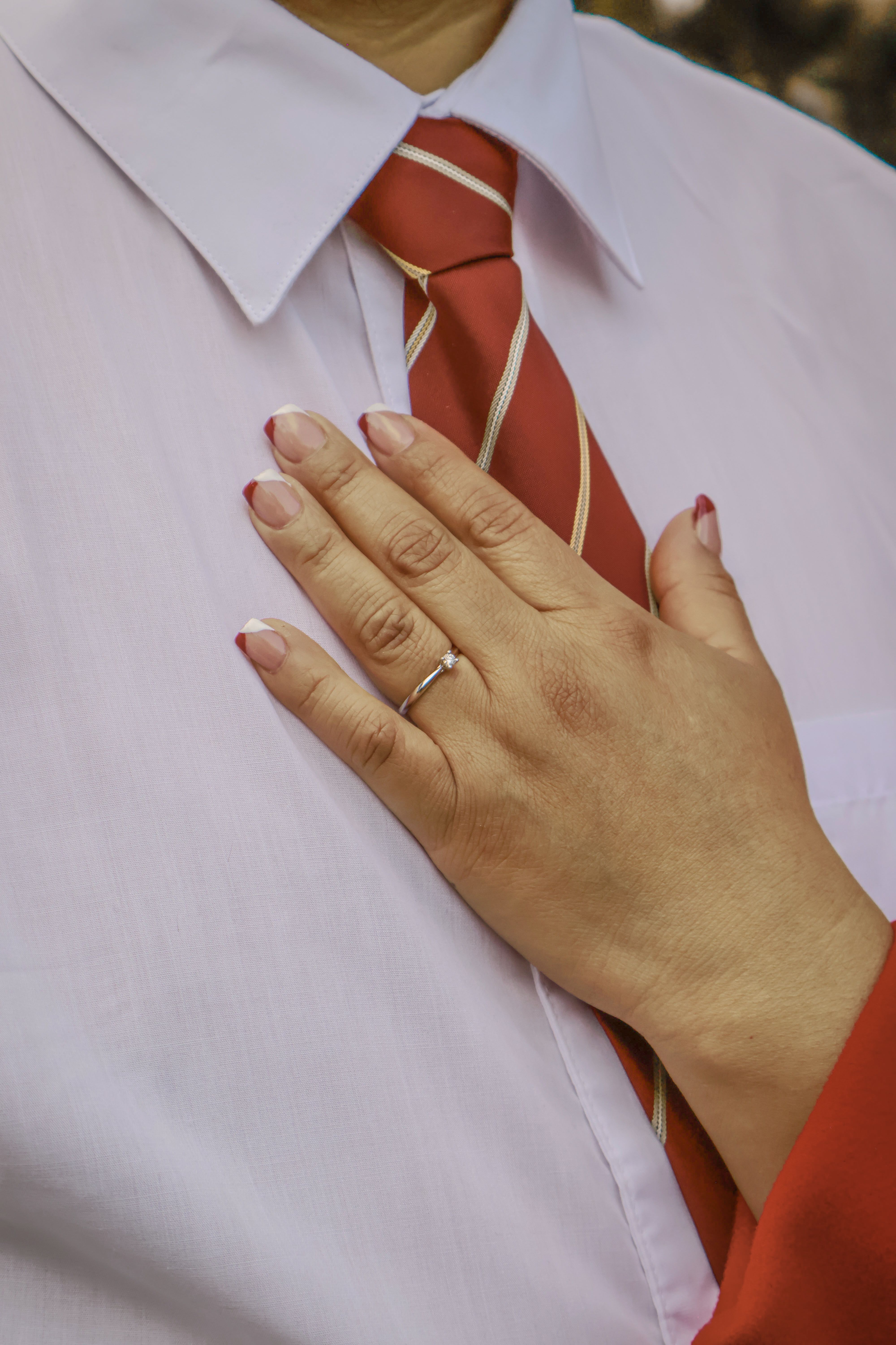 Close-up of Hand on Chest with Ring · Free Stock Photo