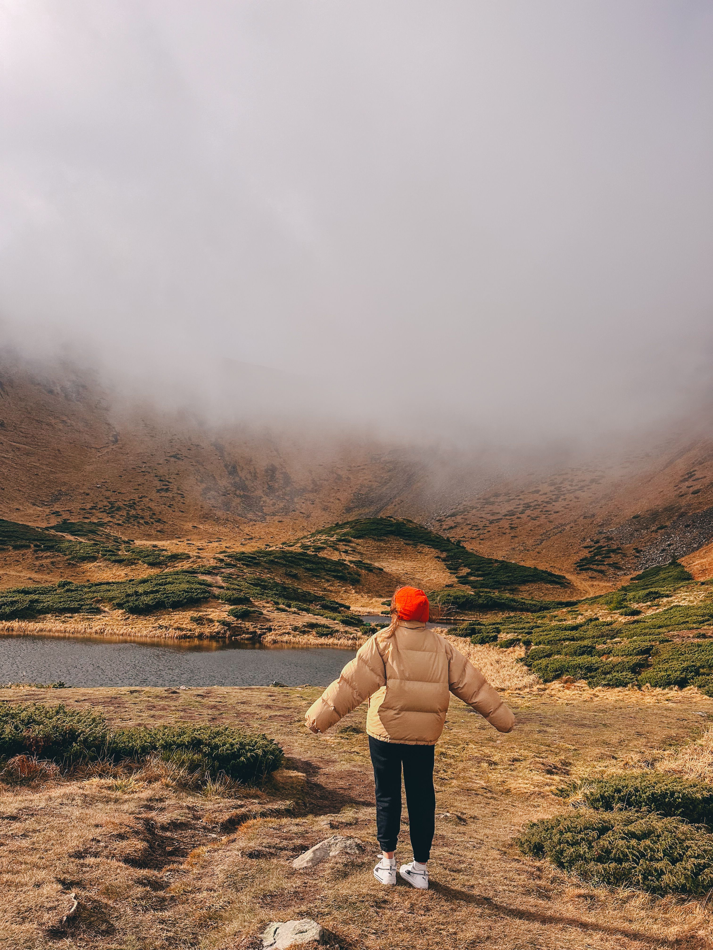 Person in Autumn Landscape with Misty Mountains · Free Stock Photo