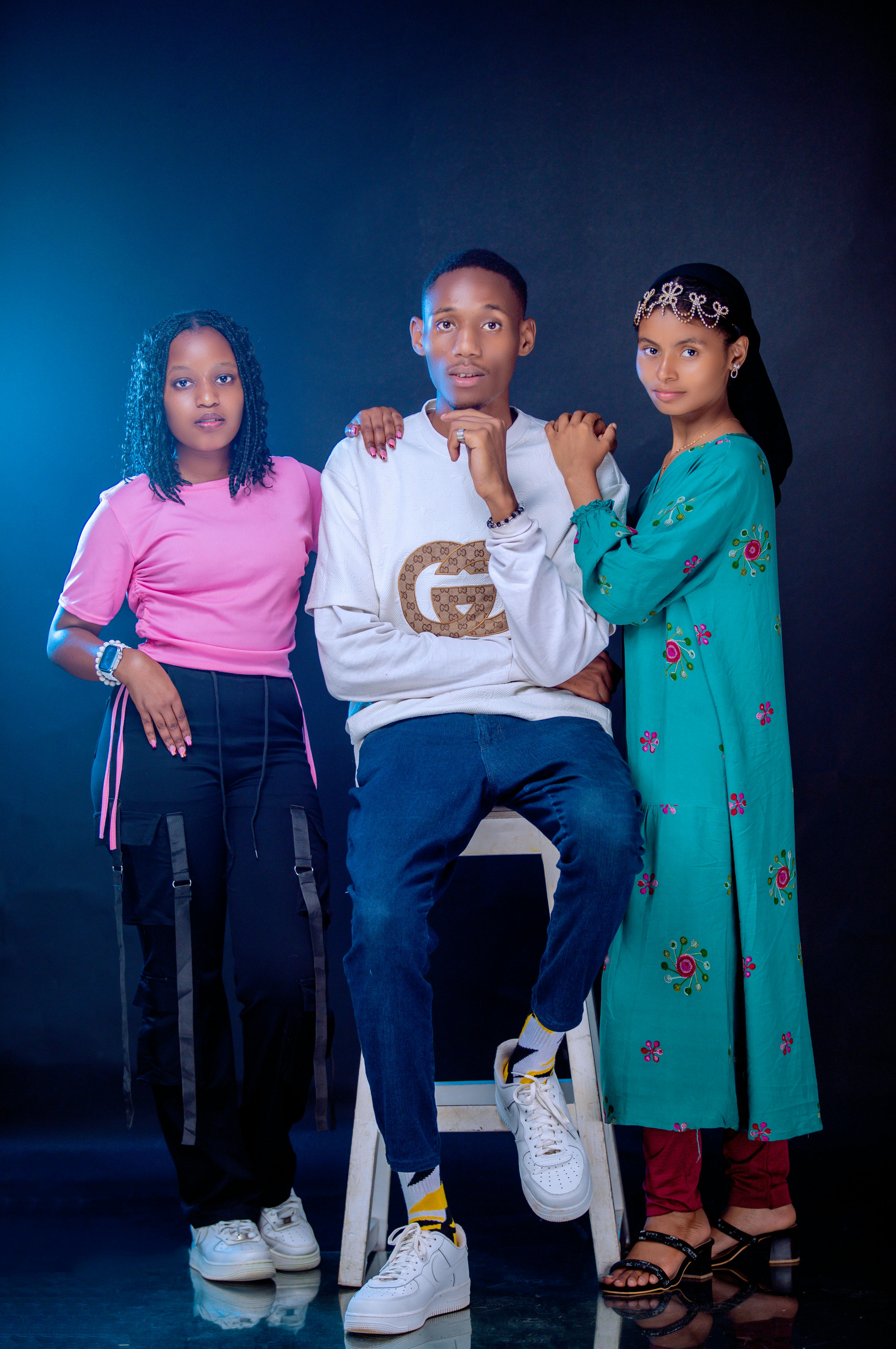 Young people posing in vibrant fashion studio portrait · Free Stock Photo