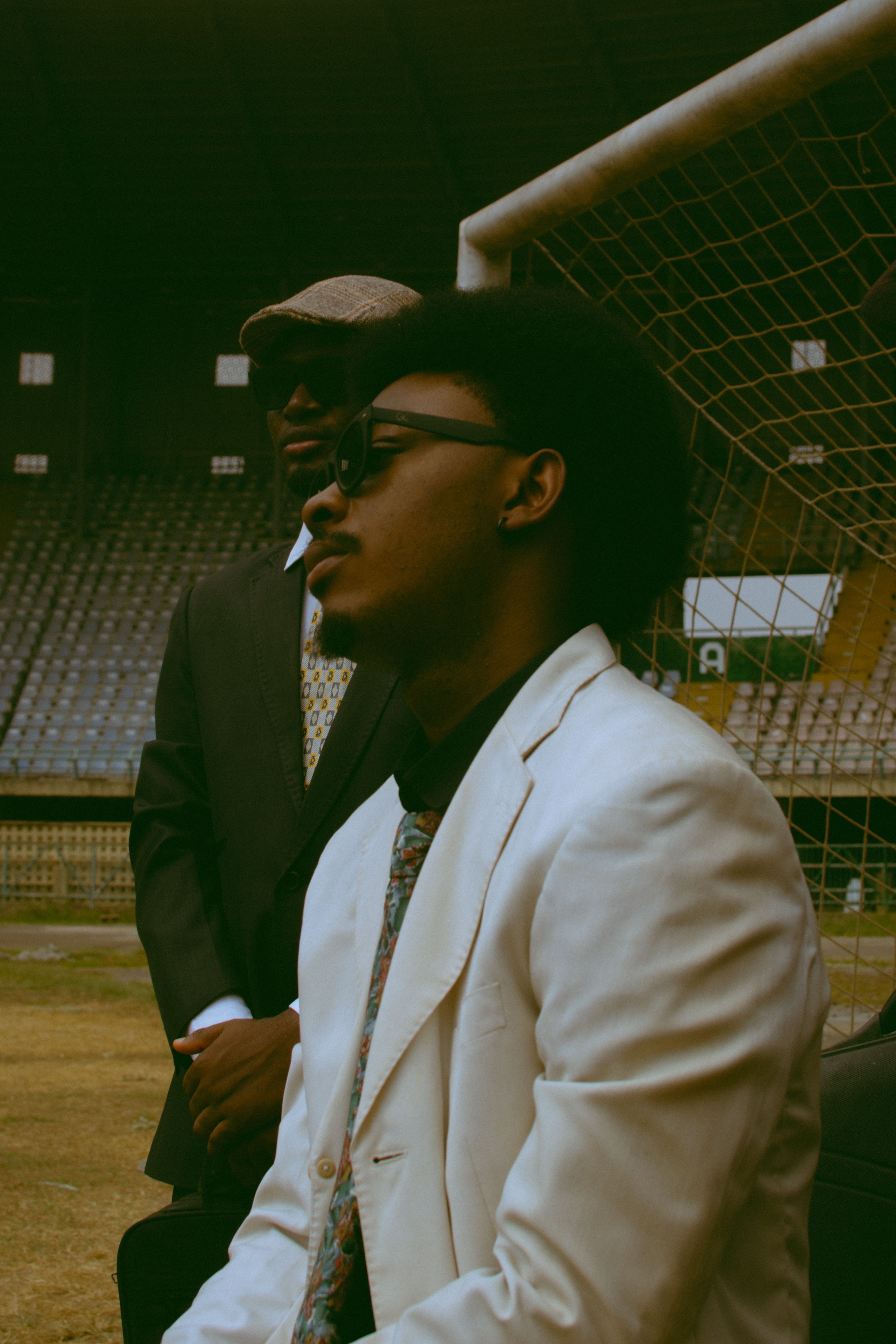 Stylish Men in Suits at Football Field · Free Stock Photo