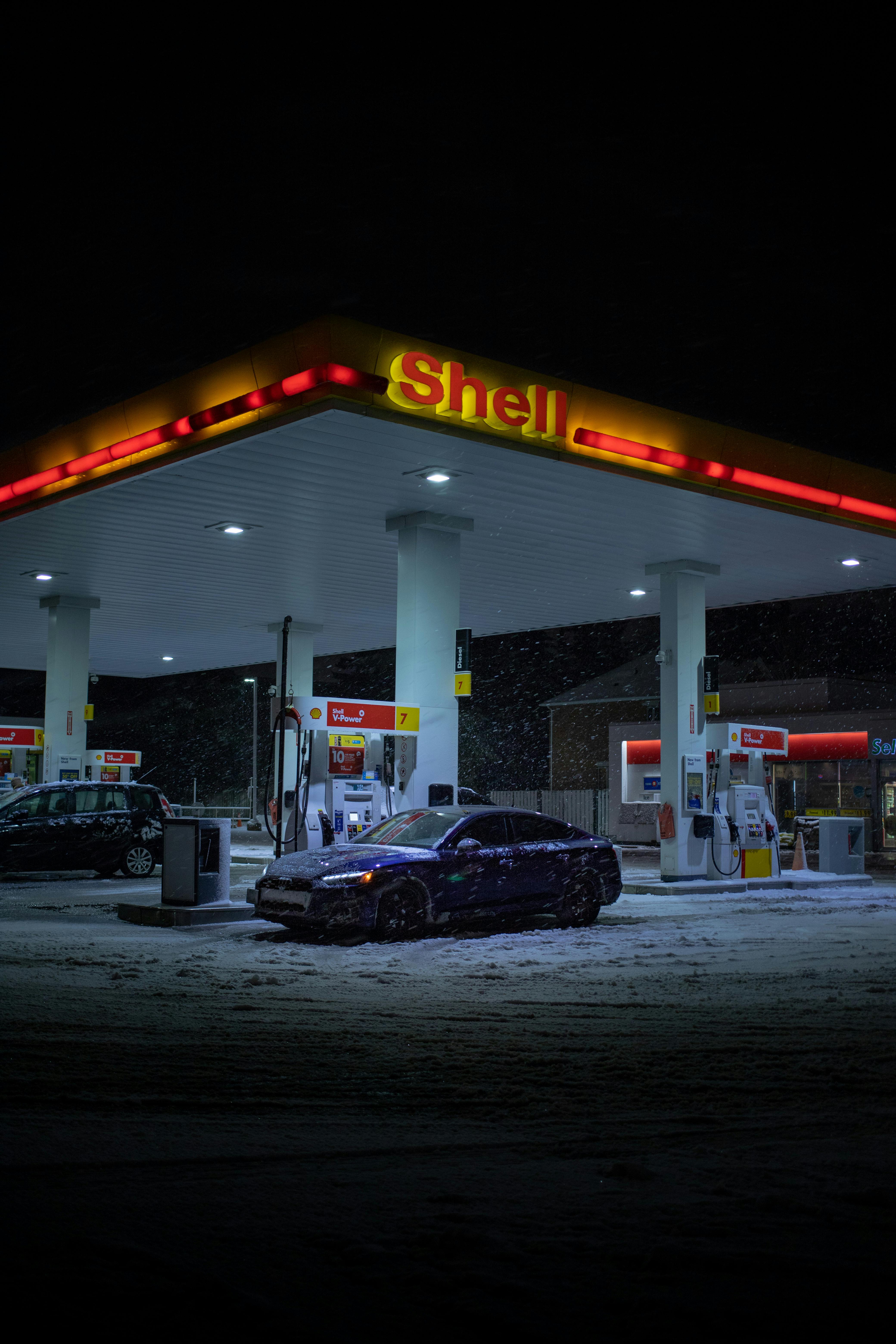 Nighttime Shell Gas Station with Snowfall · Free Stock Photo