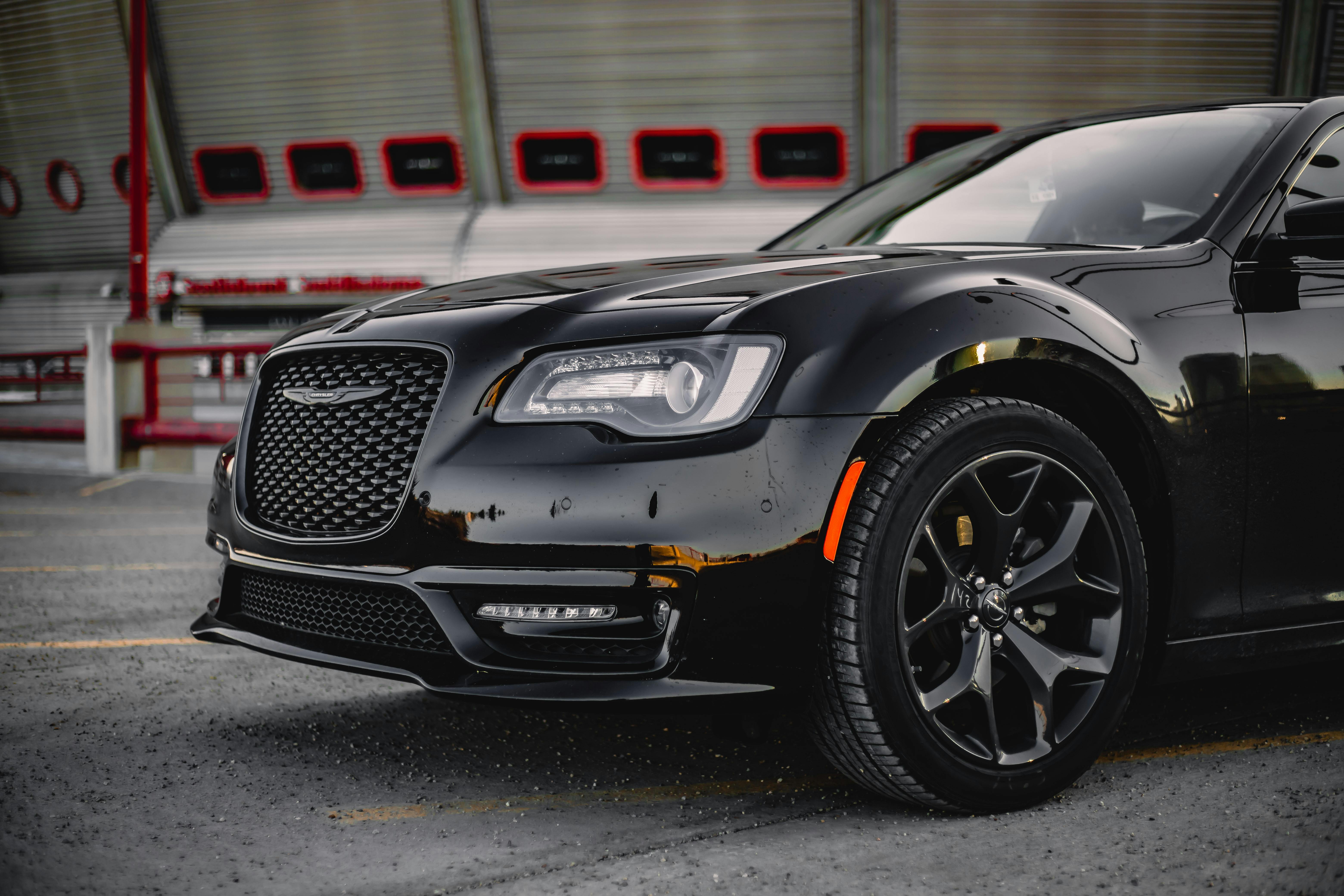 Sleek Black Luxury Car in Urban Setting · Free Stock Photo