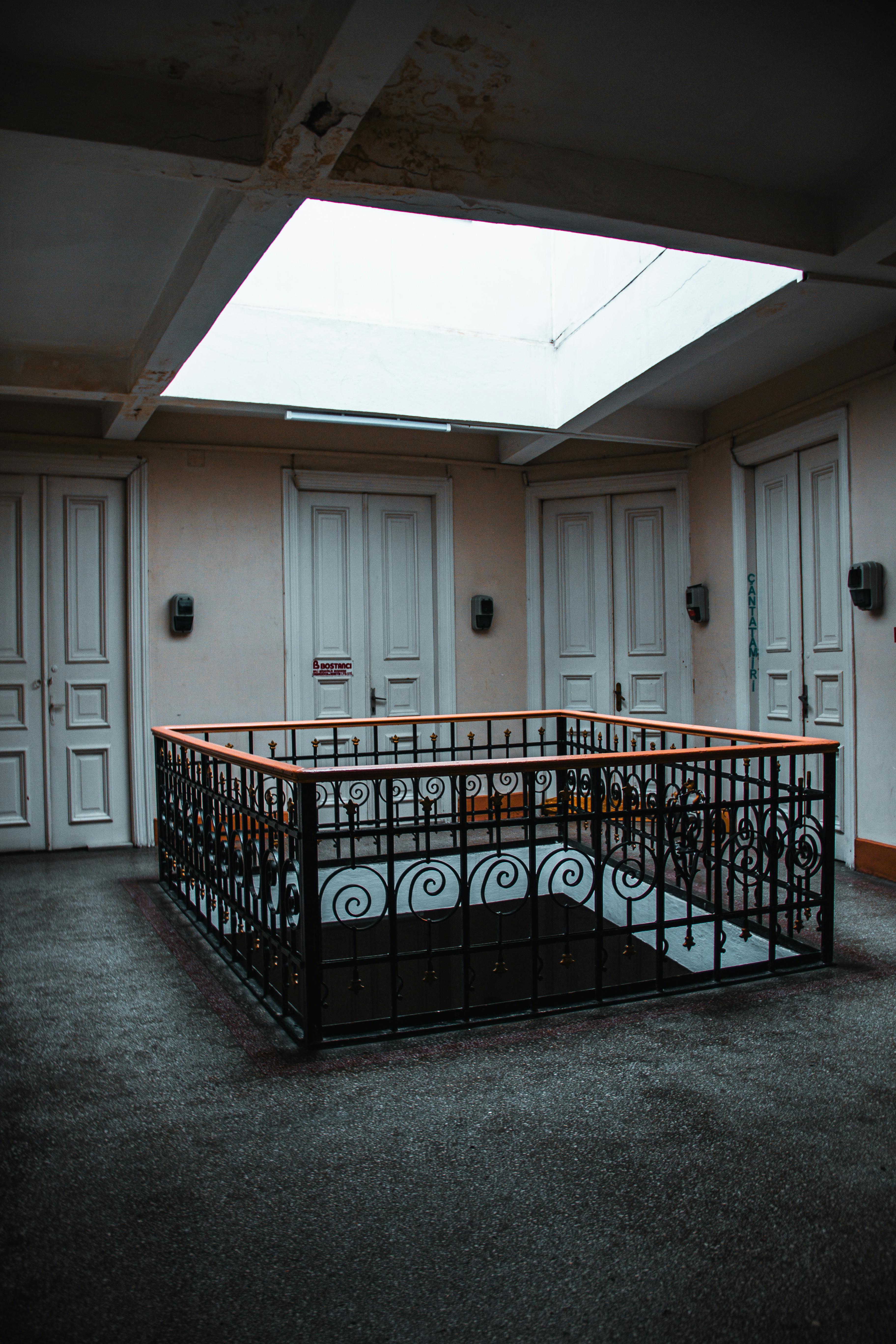 Indoor Atrium with Iron Railing and Skylight · Free Stock Photo