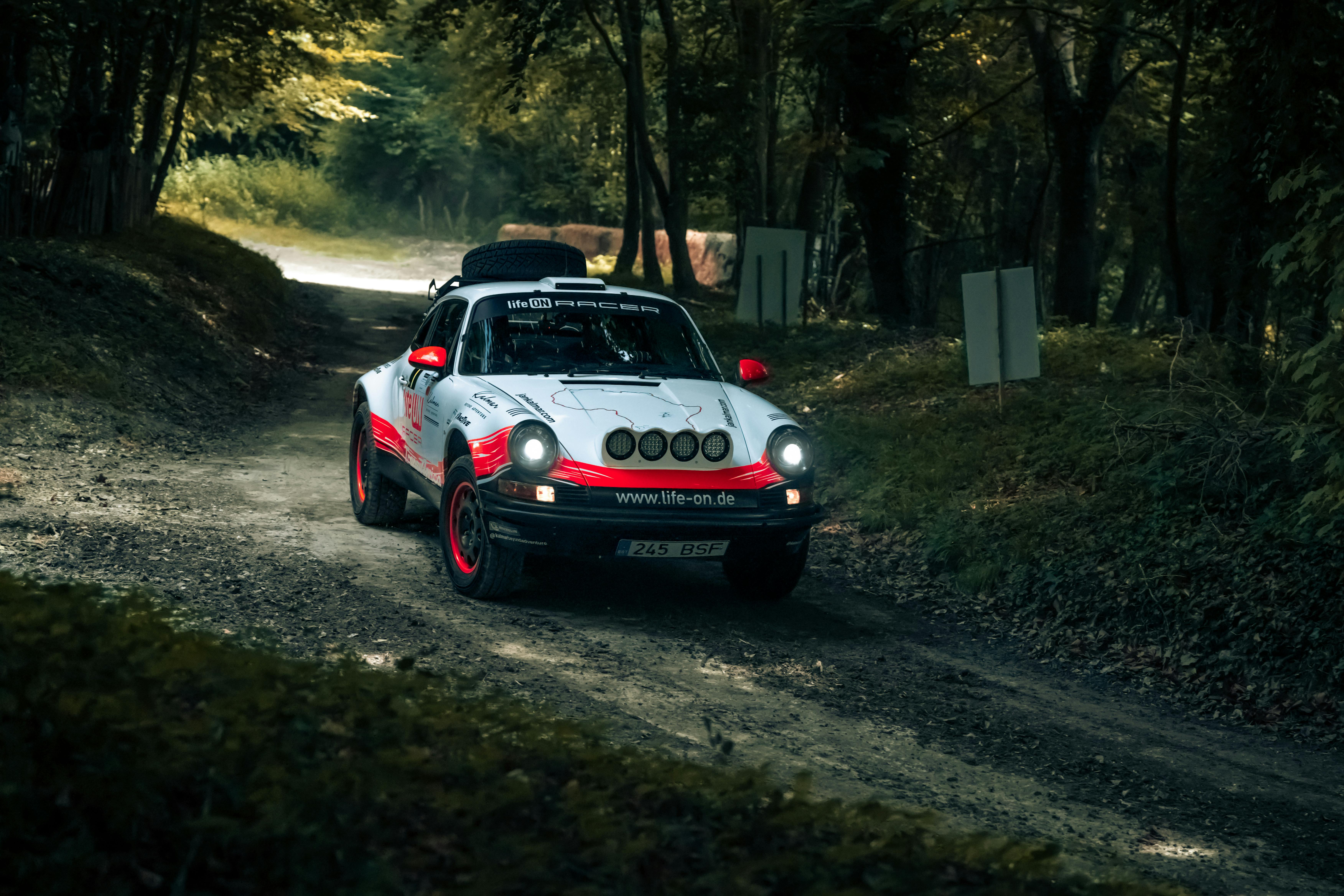 Porsche Rally Car Navigating Forest Track · Free Stock Photo