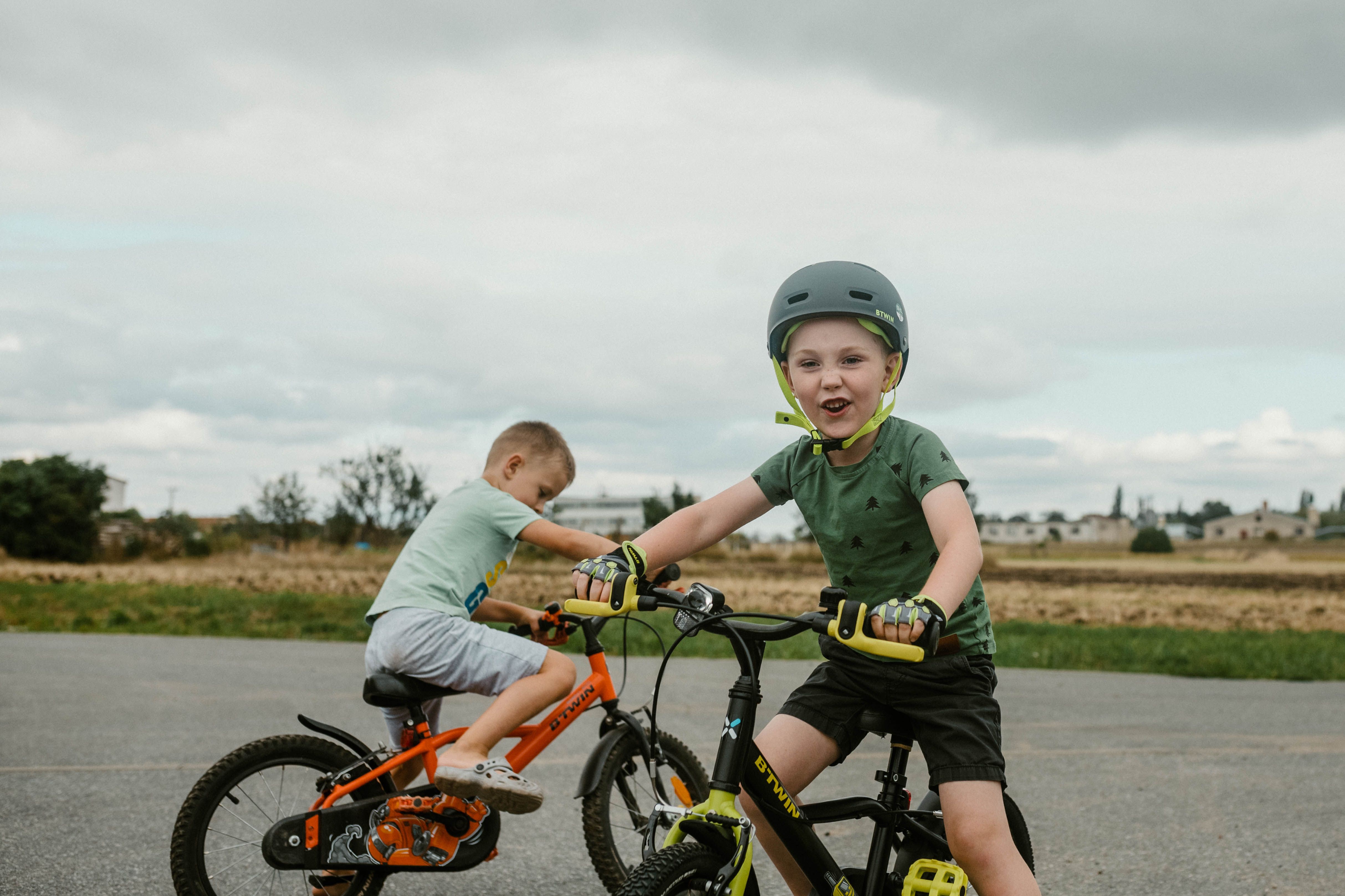 Young boys enjoying a bicycle ride outdoors · Free Stock Photo