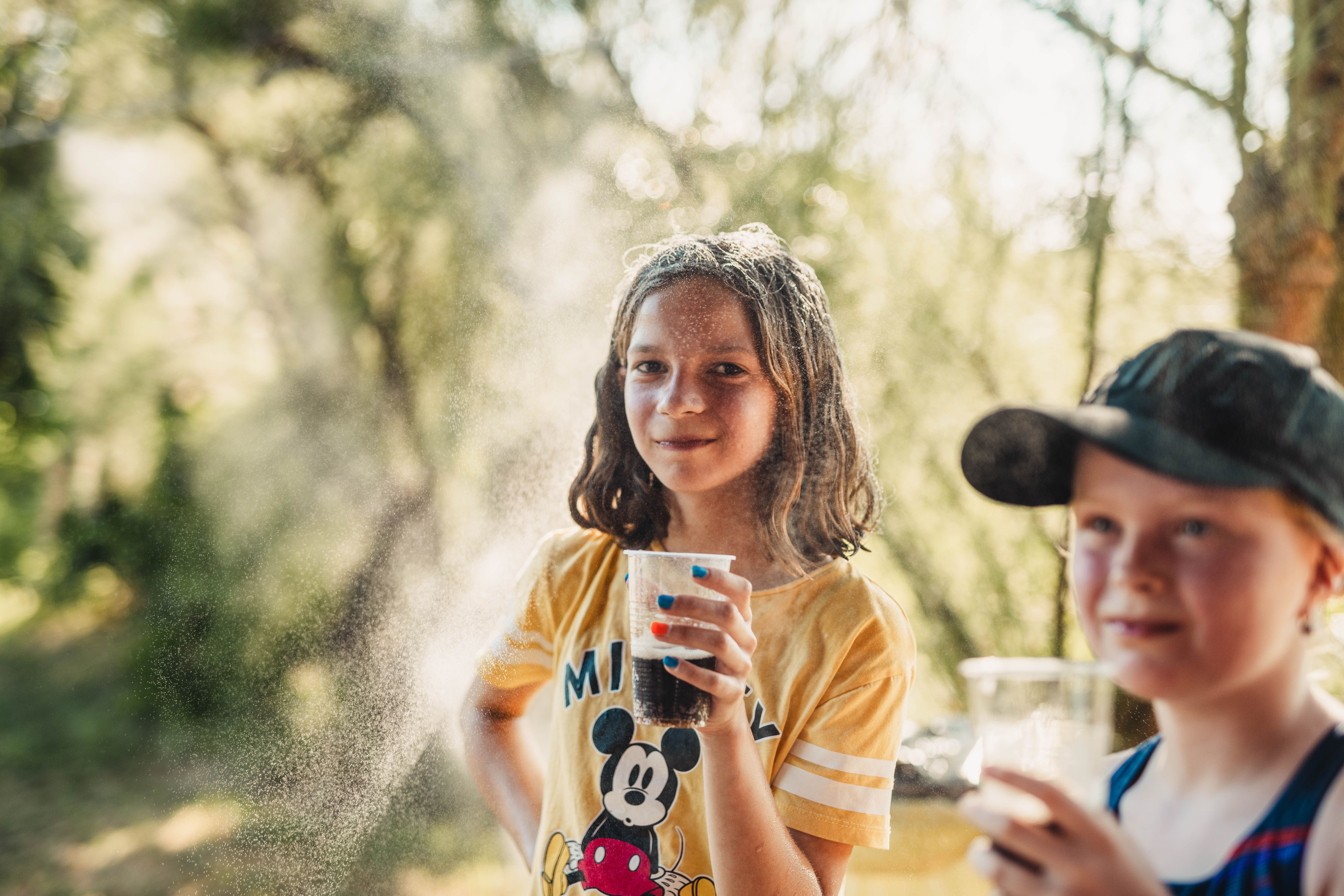Two Kids Enjoying a Refreshing Drink Outdoors · Free Stock Photo