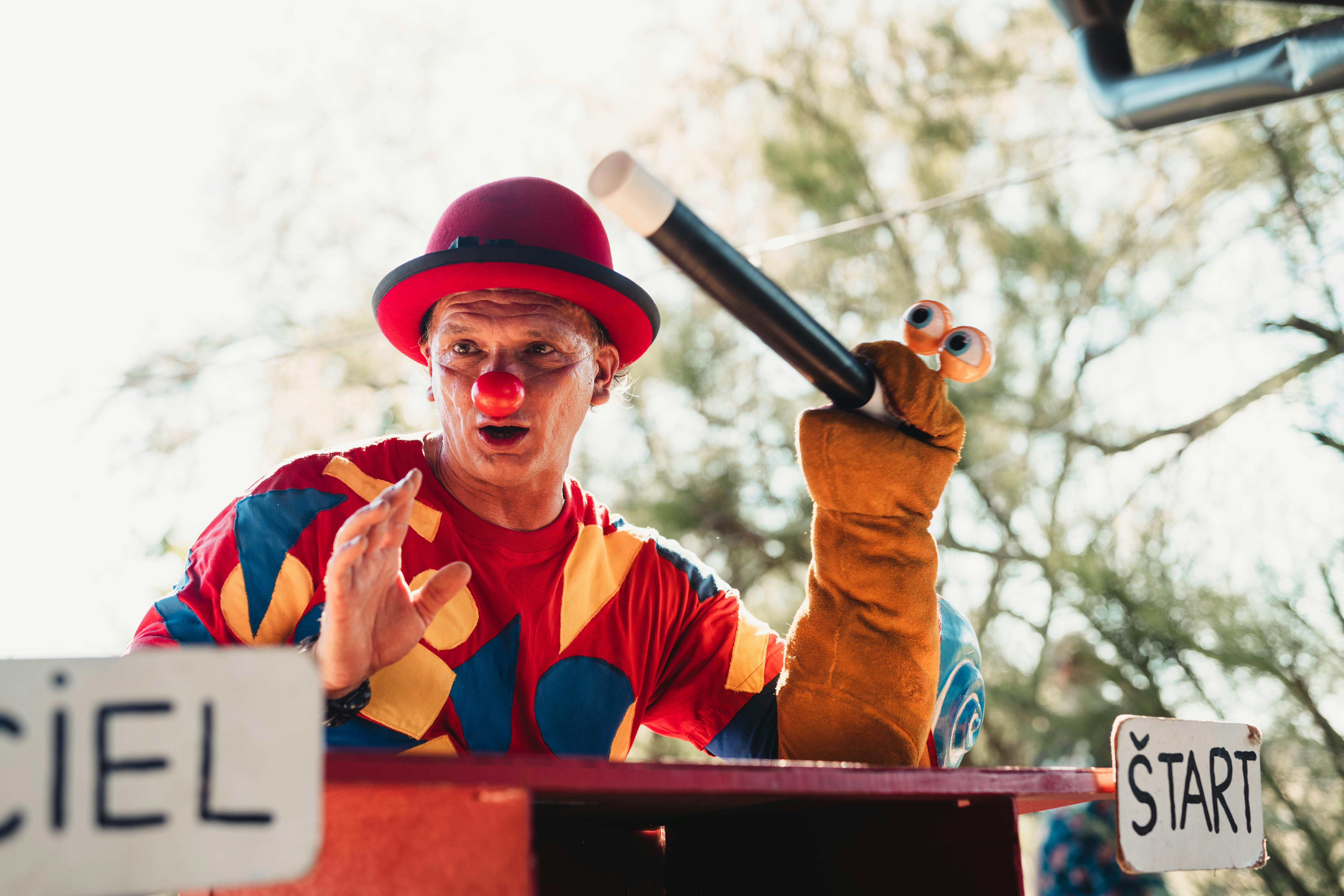 Colorful Clown Entertaining Outdoors at Carnival · Free Stock Photo