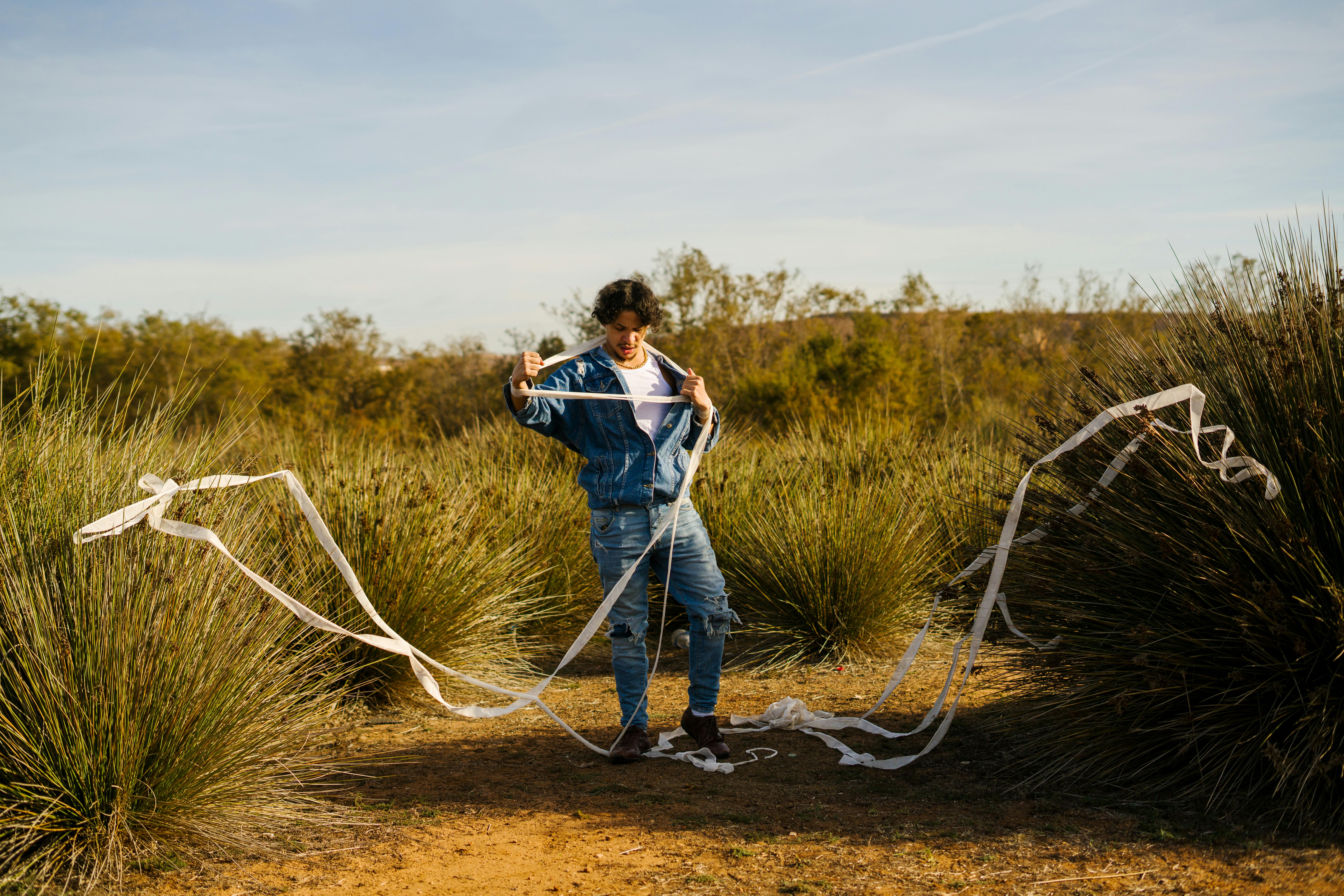 Man Outdoors with Streamers in Natural Setting · Free Stock Photo