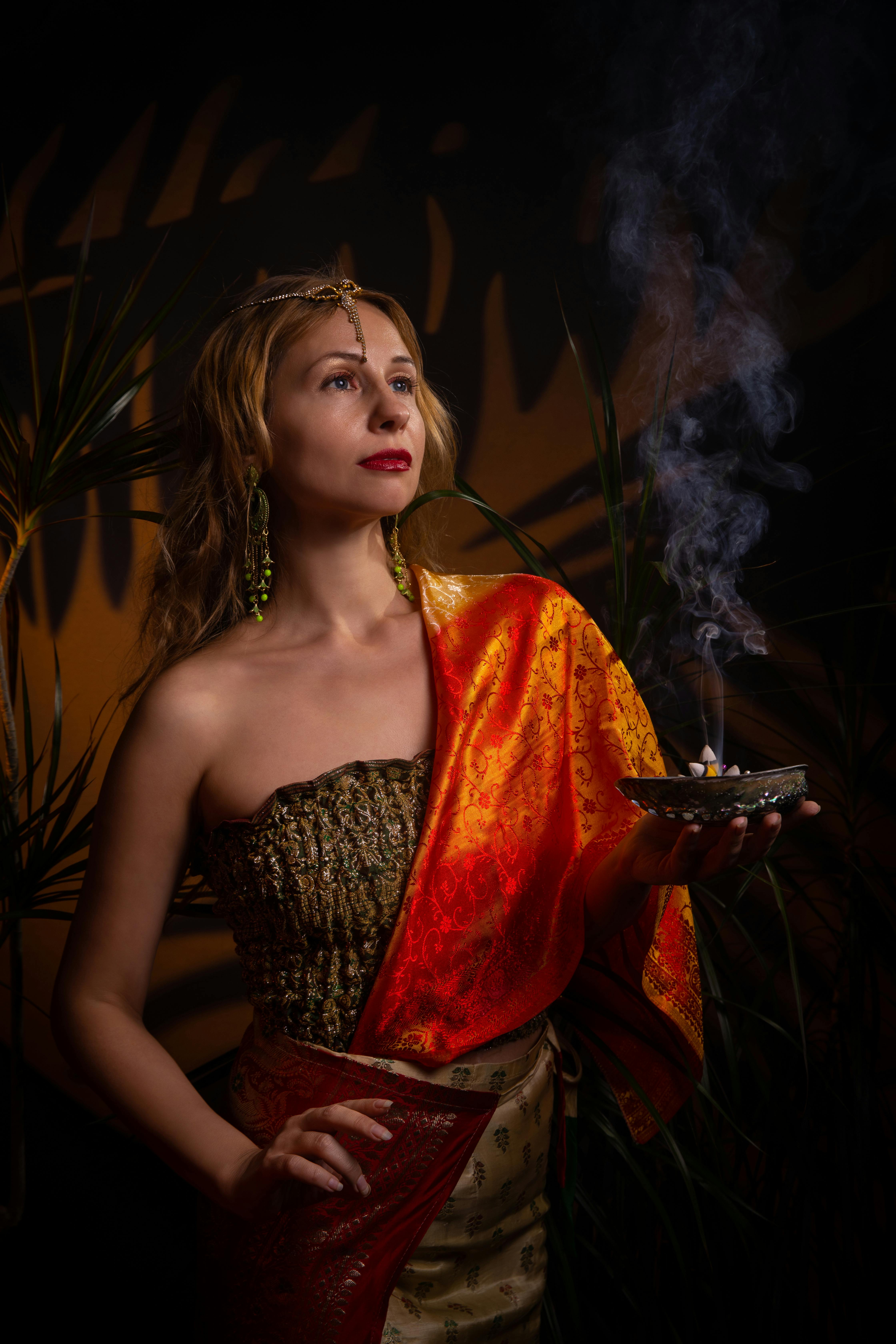 Woman in Traditional Attire with Incense Ceremony · Free Stock Photo