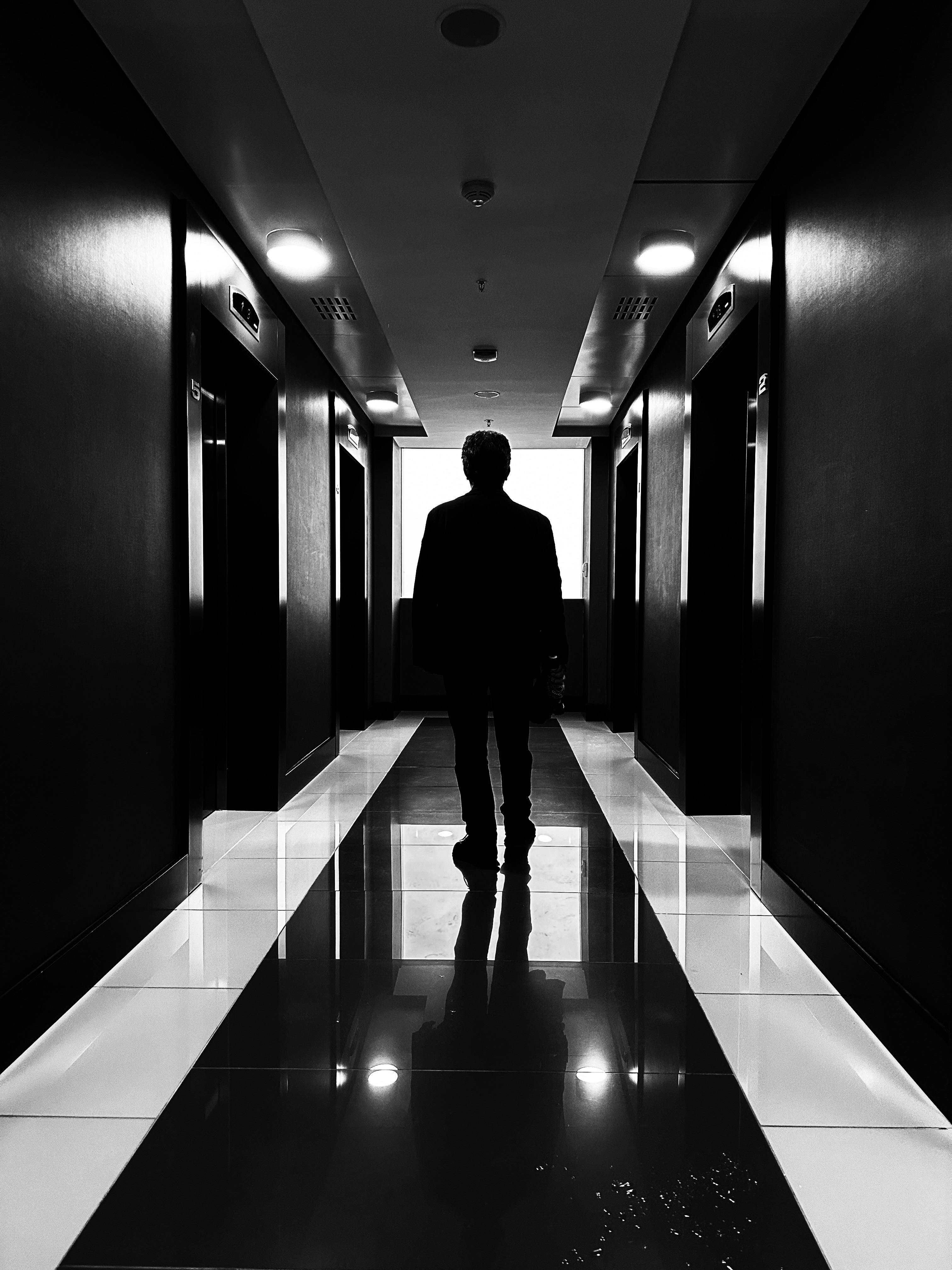 Silhouette of a Man in a Dramatic Corridor Setting · Free Stock Photo