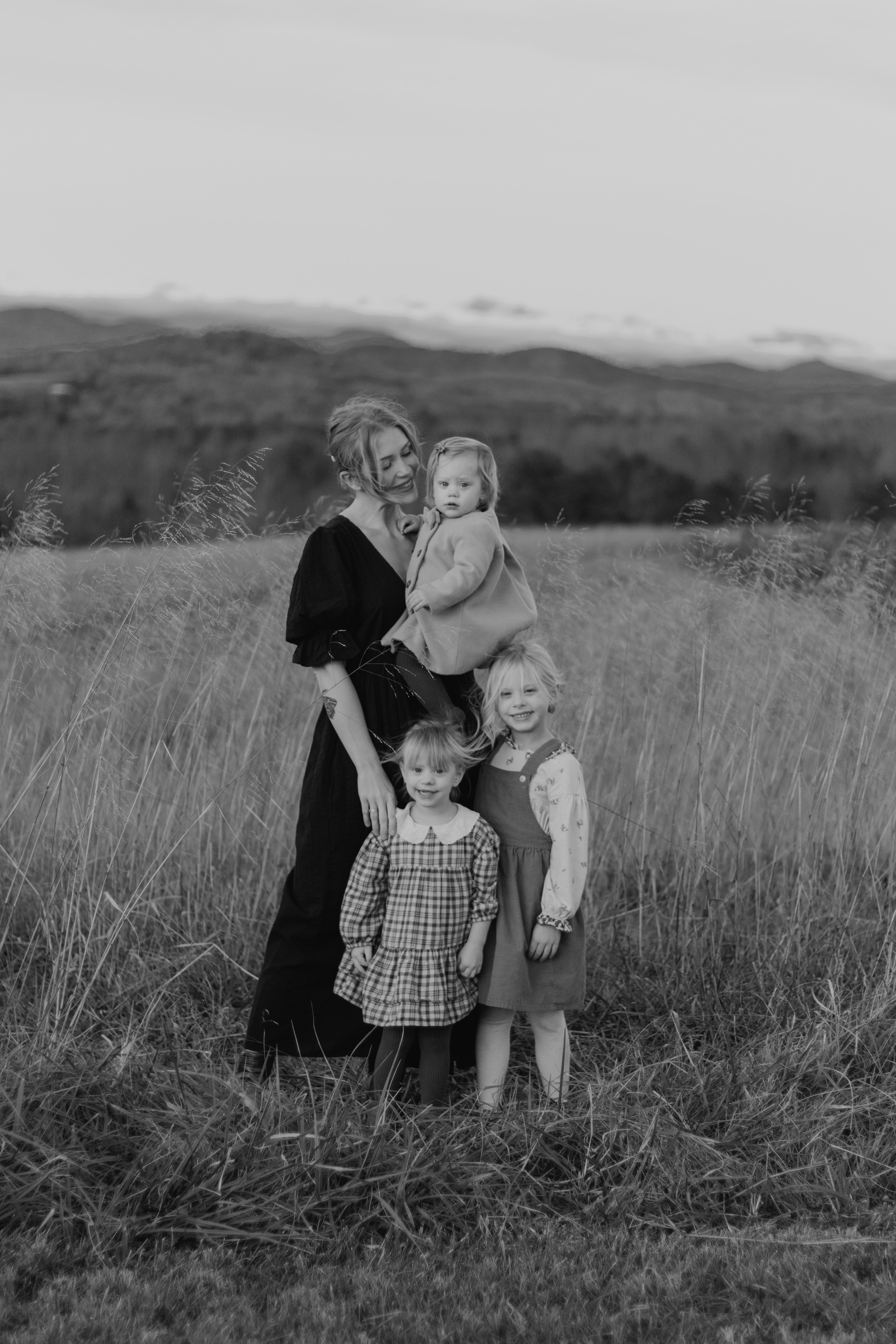 Black and White Family Portrait in Scenic Field · Free Stock Photo