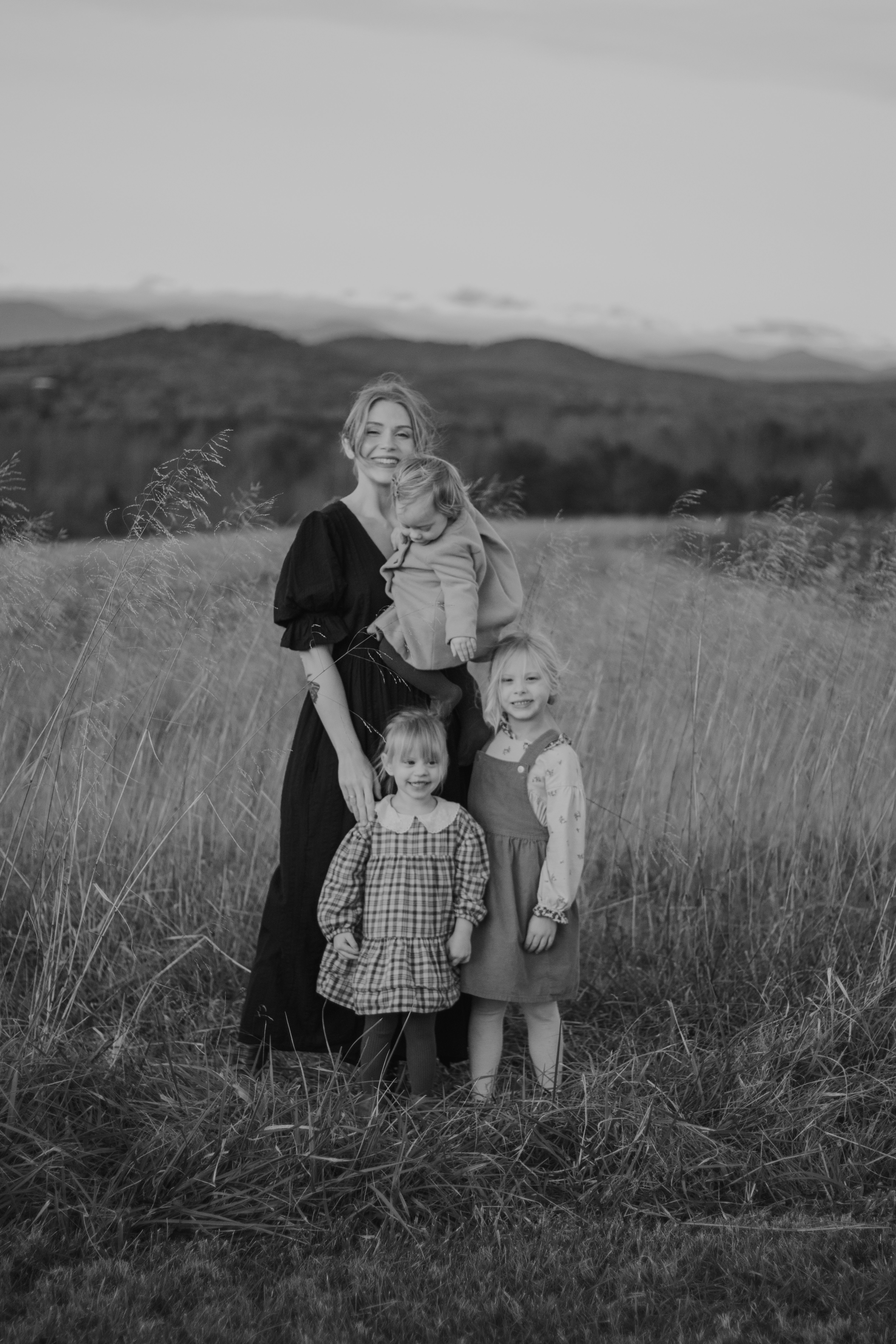 Black and White Family Portrait in Scenic Field · Free Stock Photo