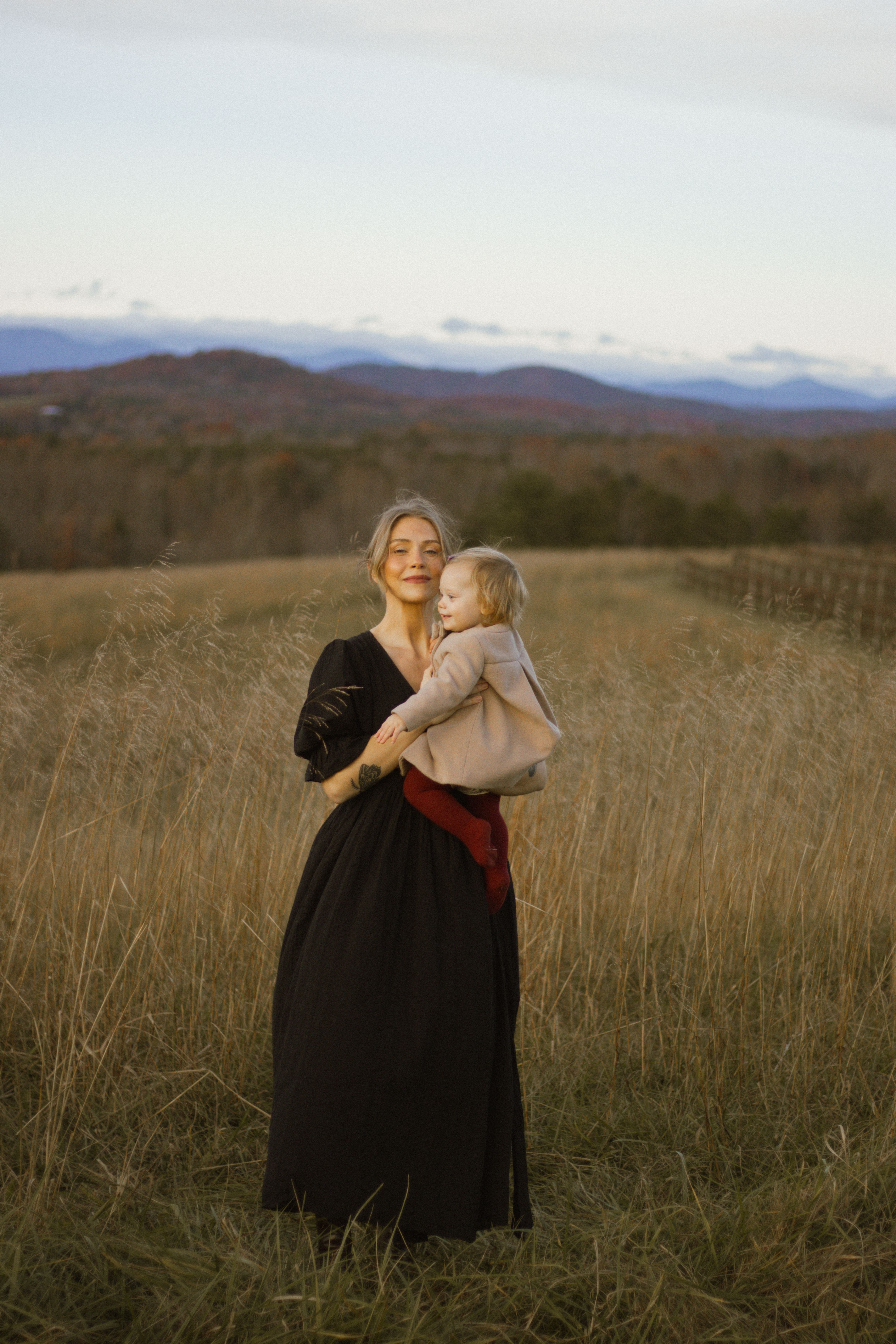 Mother and Child in Scenic Grassland Portrait · Free Stock Photo