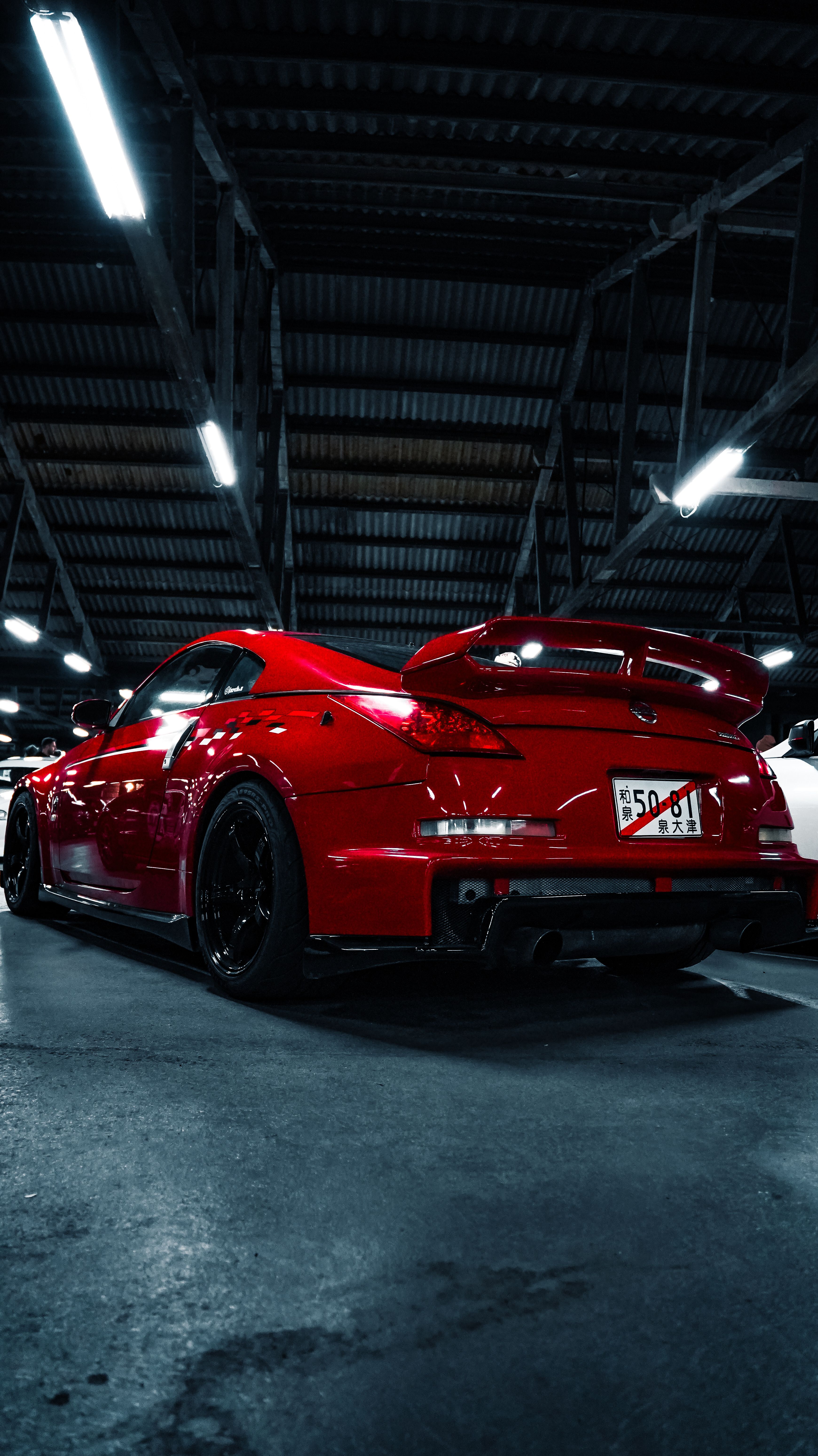 Stylish Red Sports Car in Dimly Lit Garage · Free Stock Photo