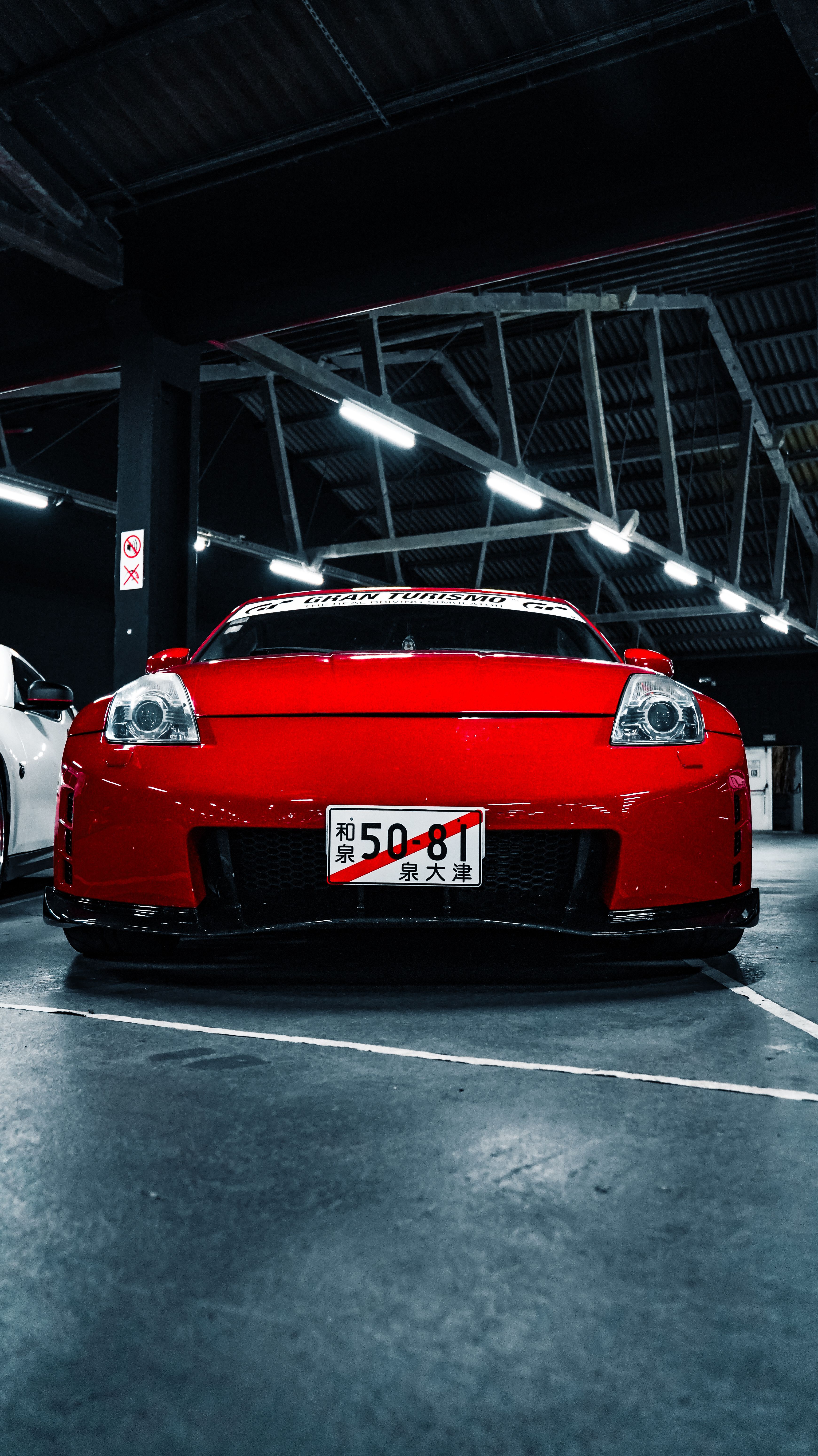 Striking Red Sports Car in Dimly Lit Garage · Free Stock Photo