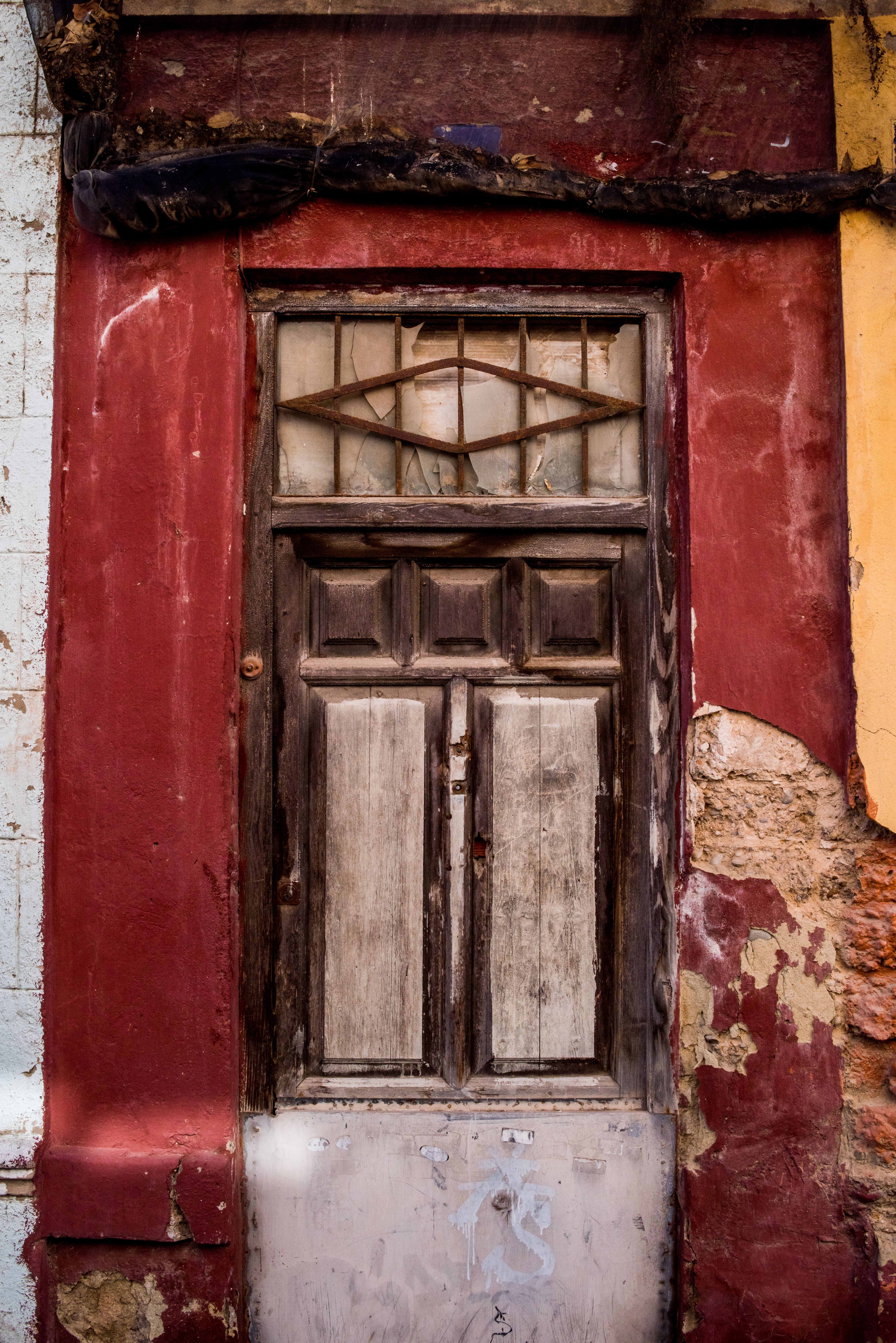Rustic Wooden Door on Distressed Red Wall · Free Stock Photo