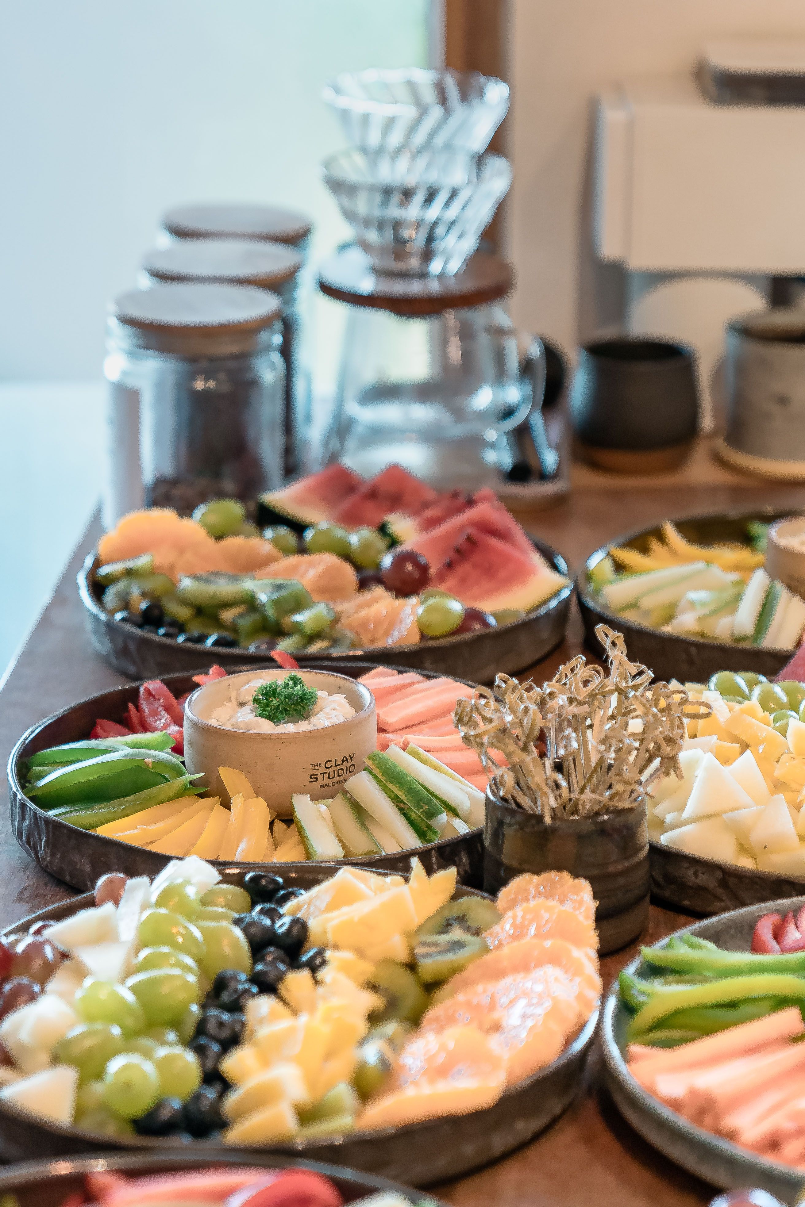 Vibrant Assorted Fruit and Cheese Platters in a Kitchen · Free Stock Photo