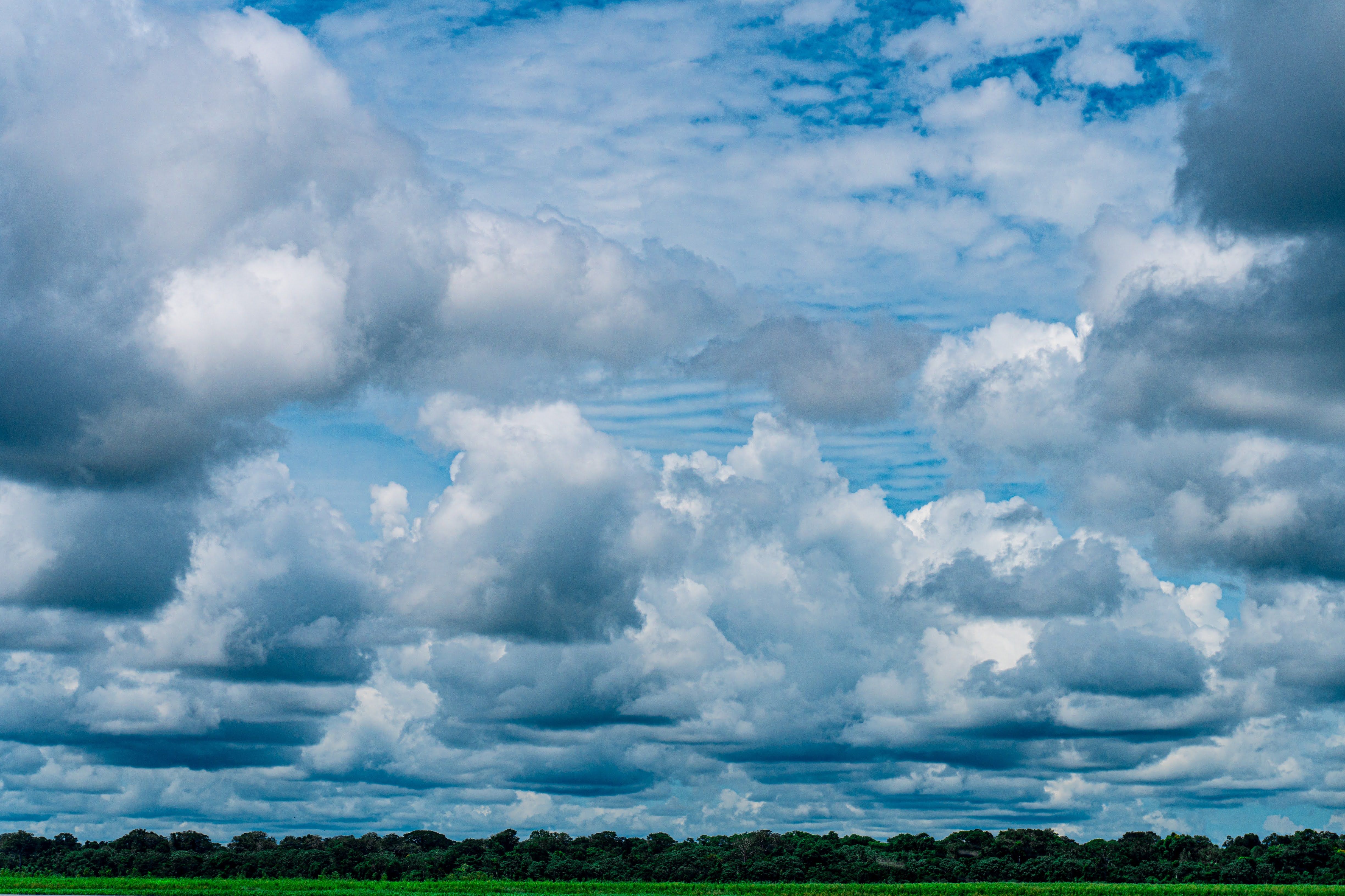 Dramatic Sky with Puffy Clouds over Landscape · Free Stock Photo