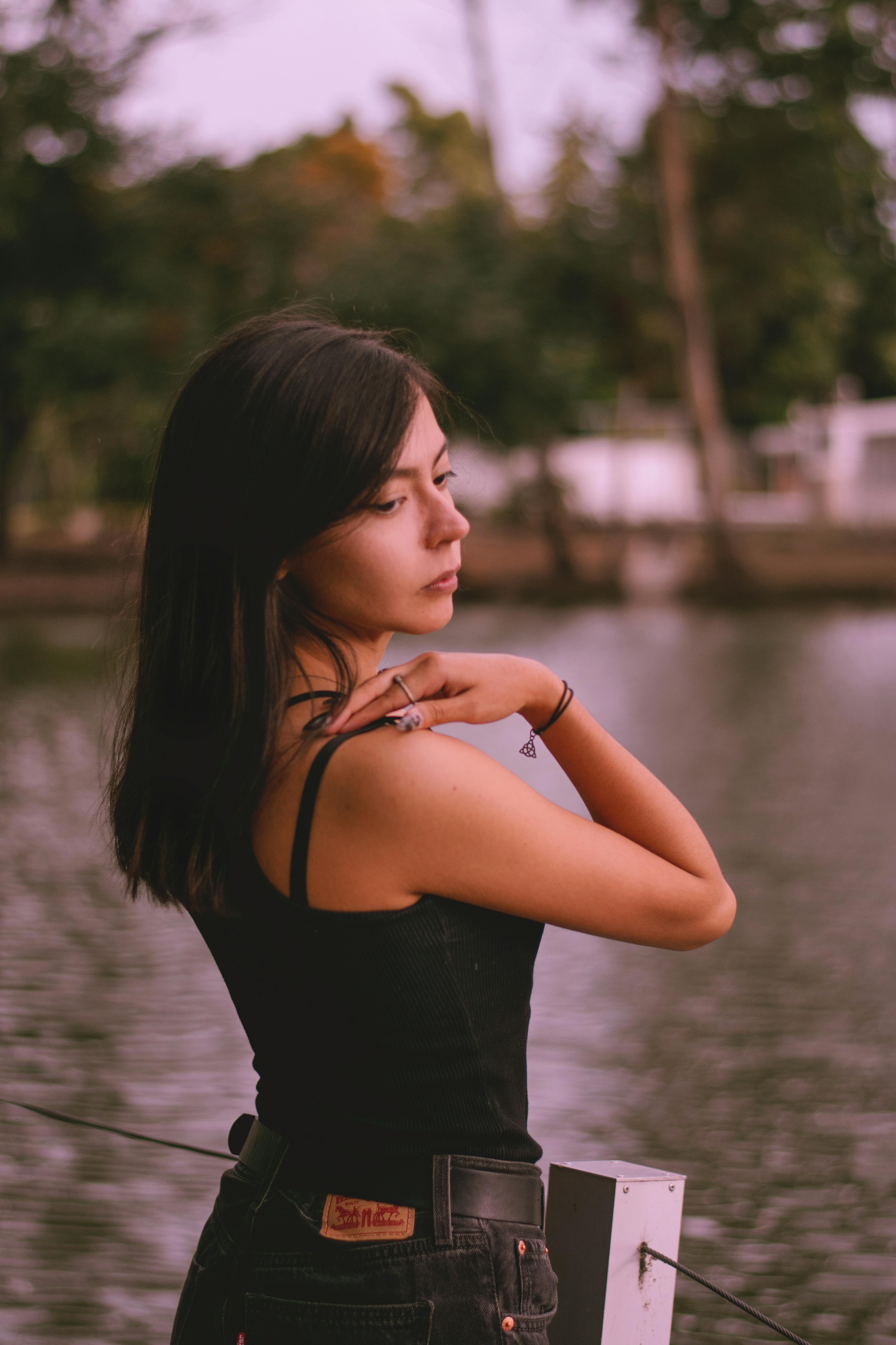 Reflective Woman by Lakeside at Sunset · Free Stock Photo