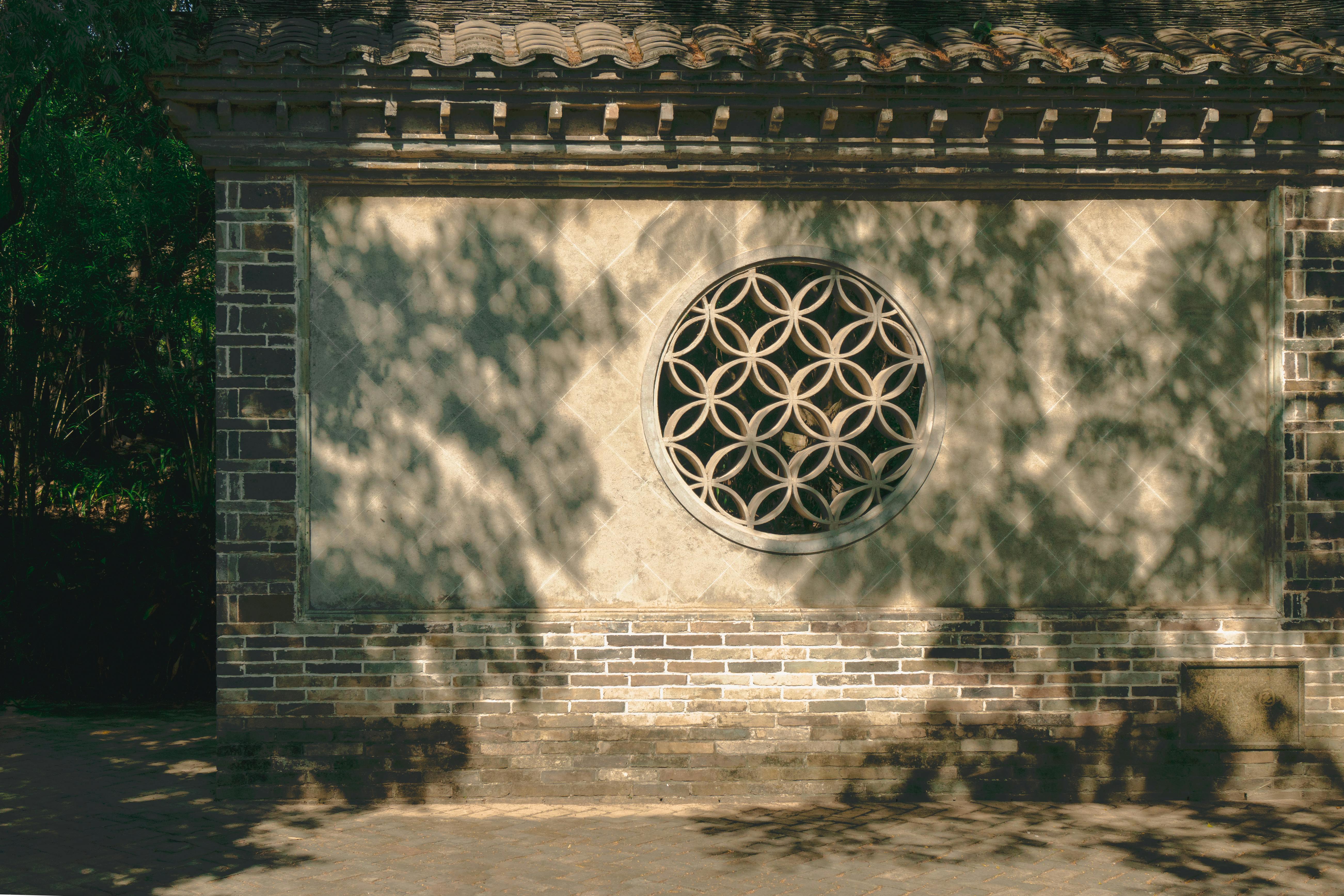 Traditional Architecture Brick Wall with Circular Window · Free Stock Photo